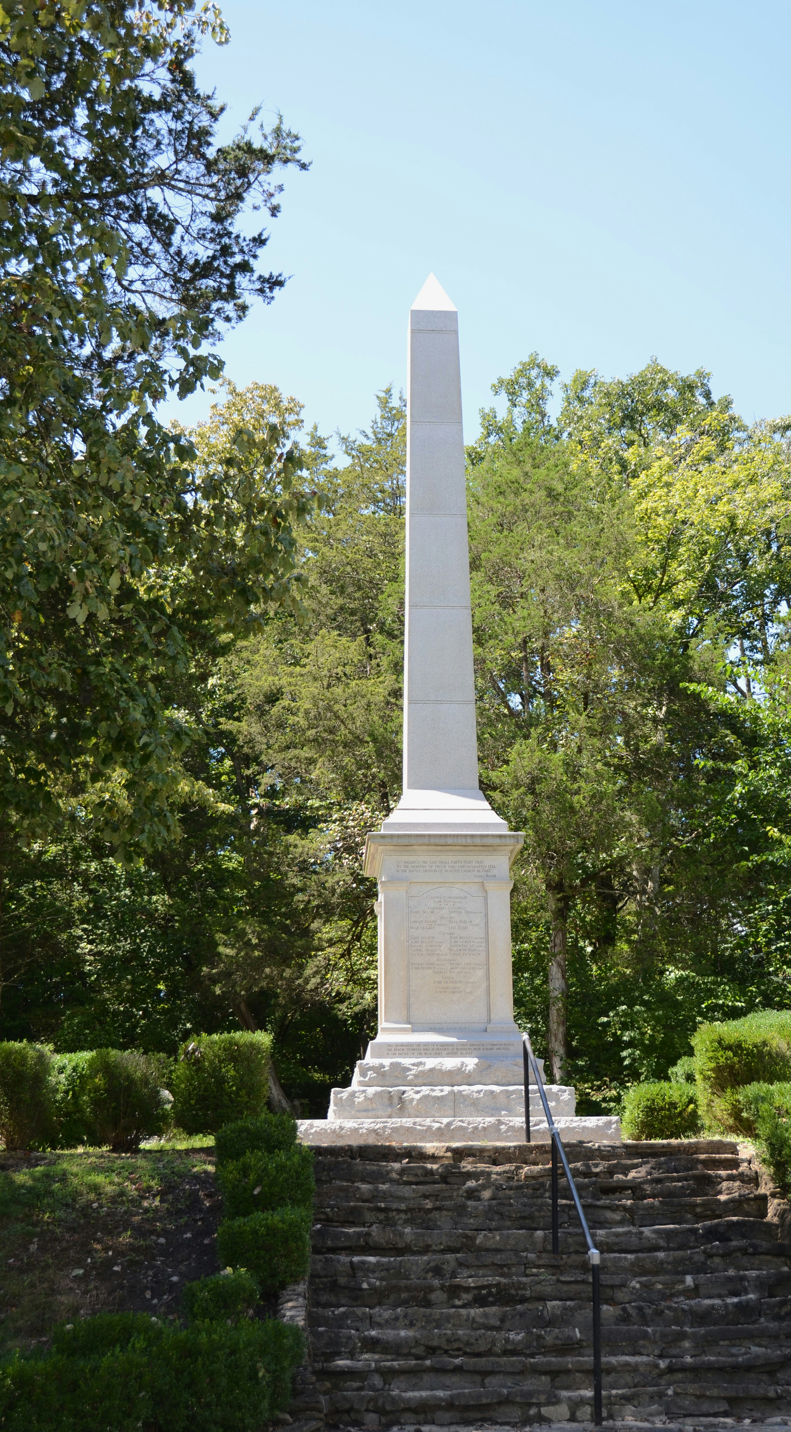 Stone Obelisk Rising from Shaded Terrace