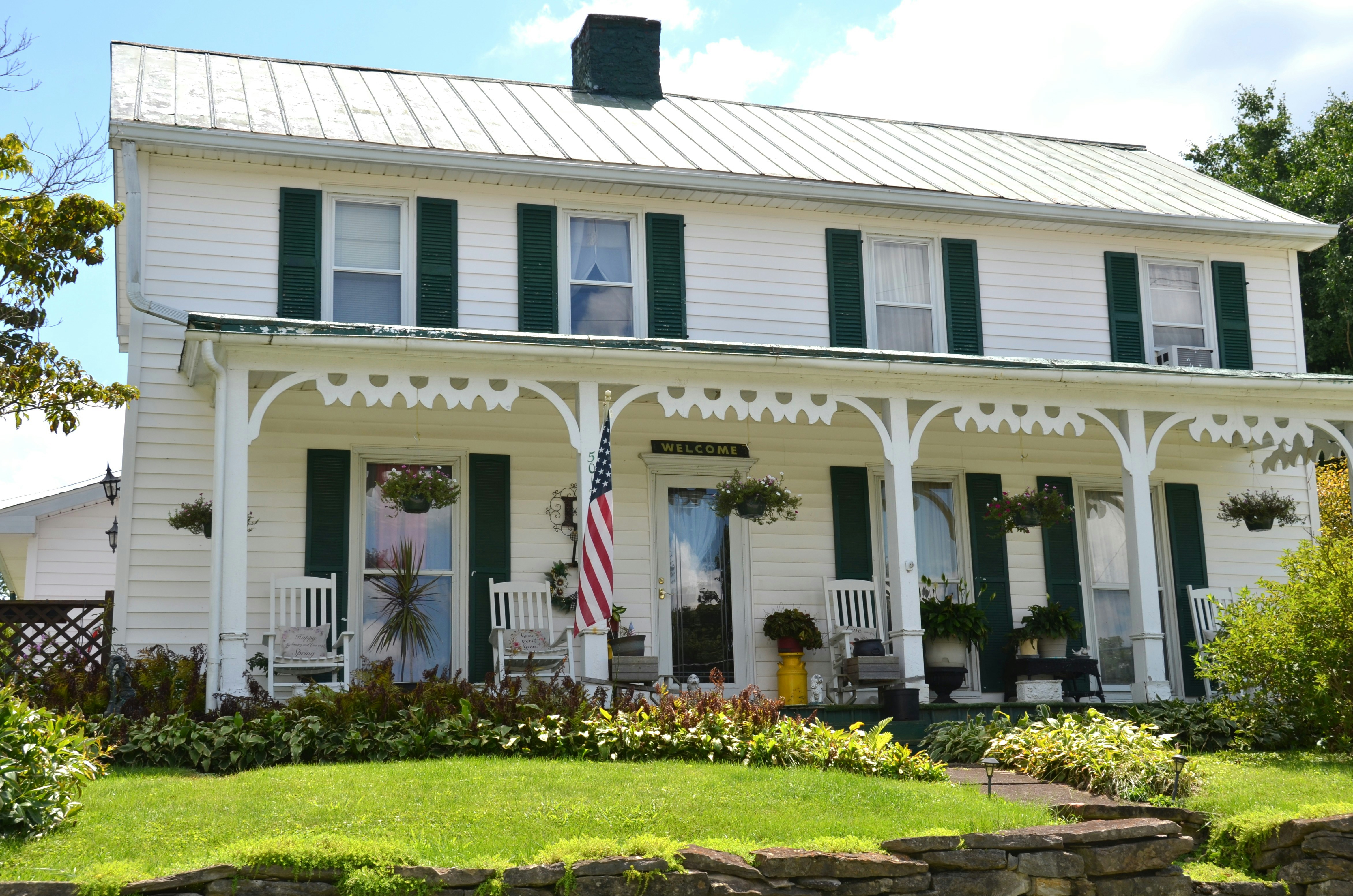 Hushed Charm: A White Southern Porch with Green Shutters