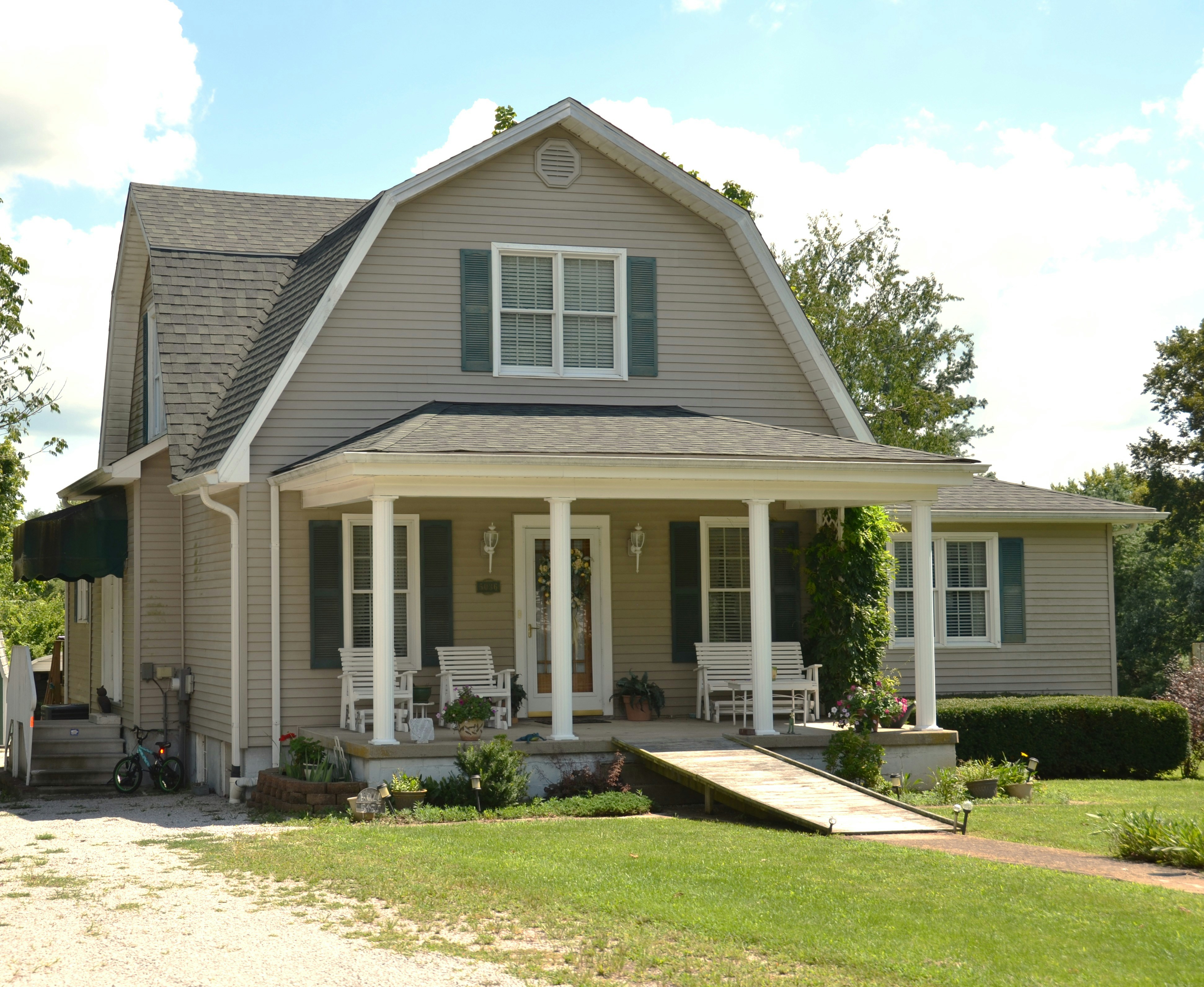 House on a Raised Porch with a Wheelchair Ramp and Climbing Vines