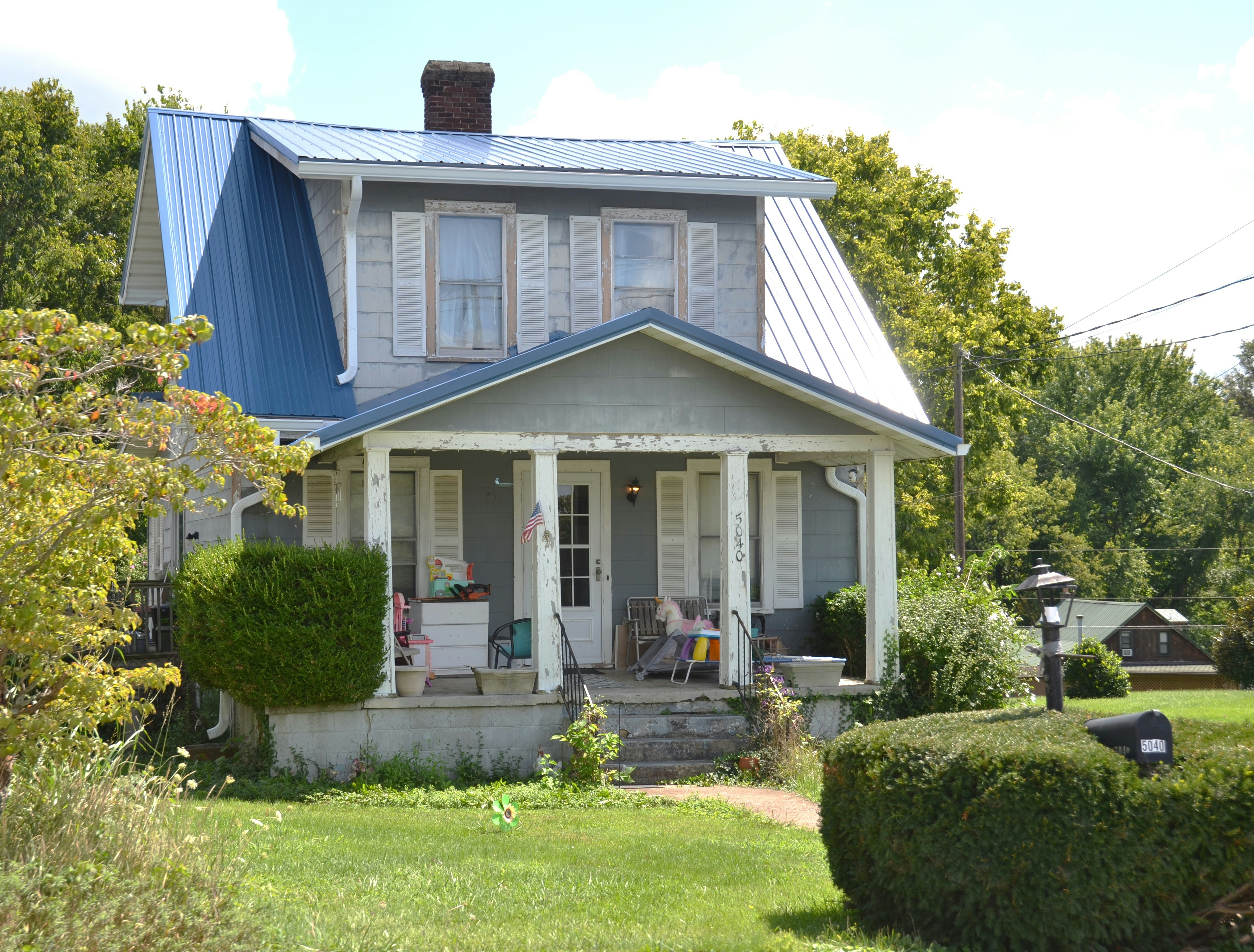 Blue-Capped Cottage: A Sunny Front Porch Portrait