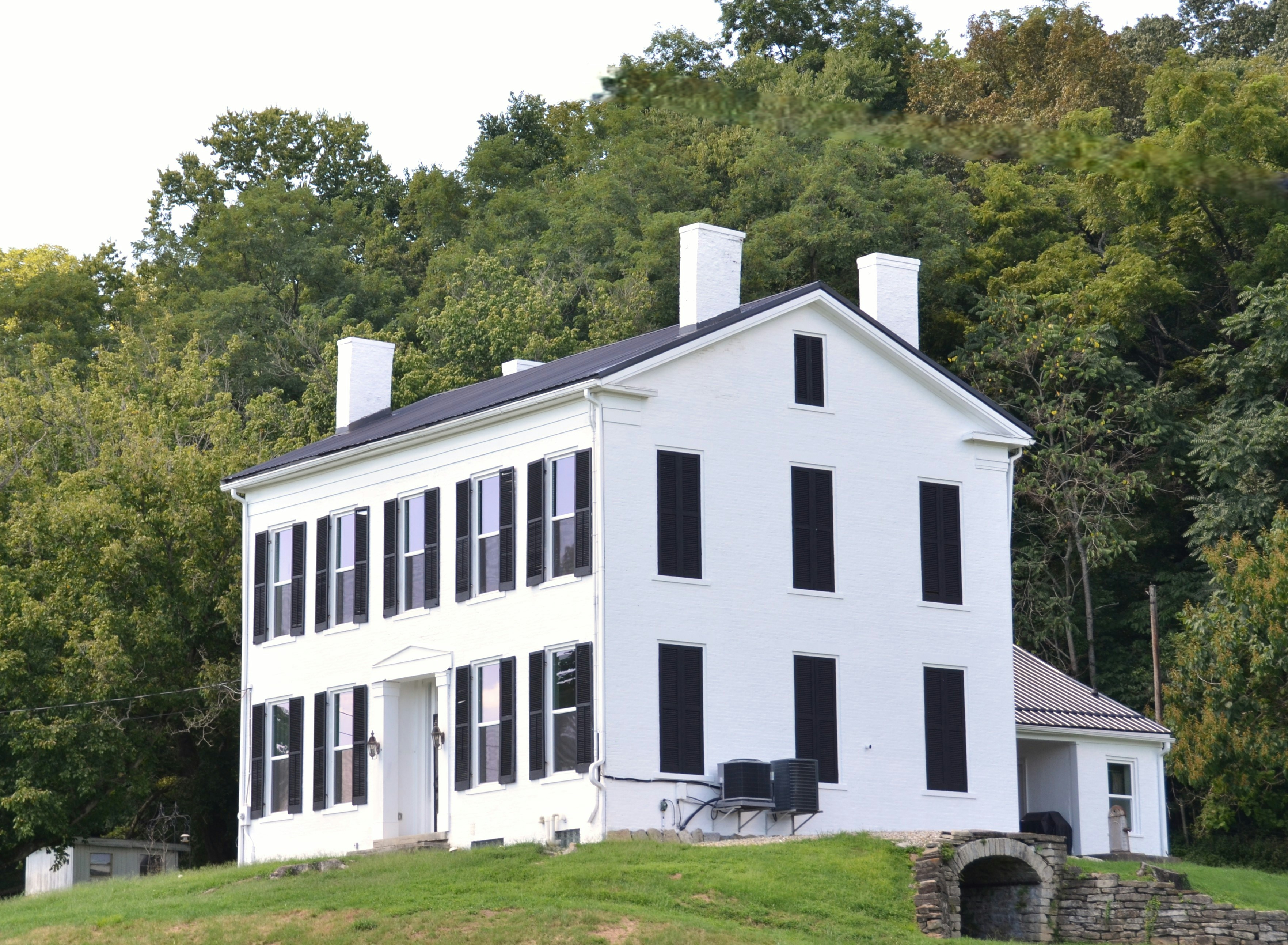 Sunlit White Manor on a Gentle Hill