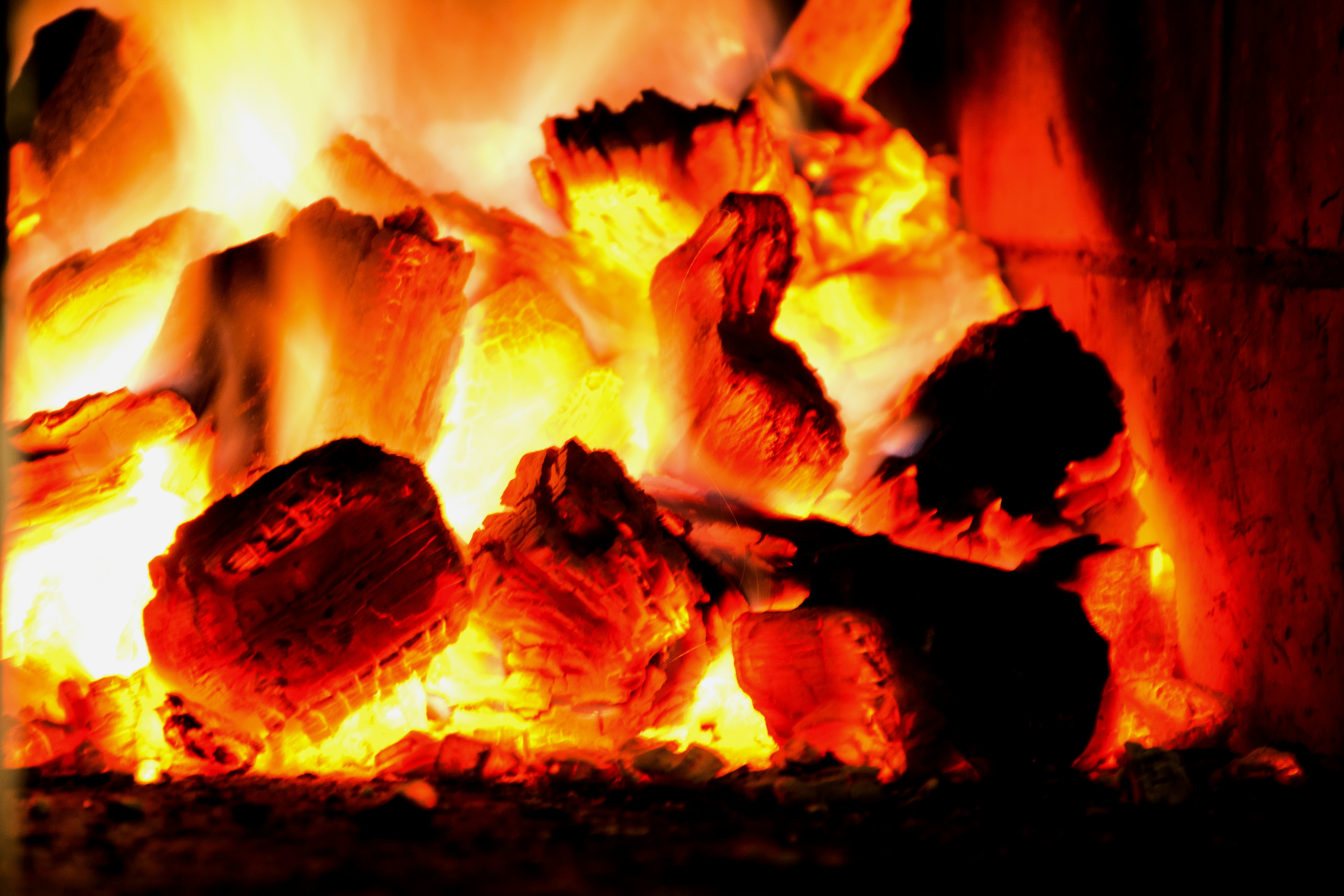 Embers in the Quiet Hearth: Deep Orange Coals Glowing Against Shadow