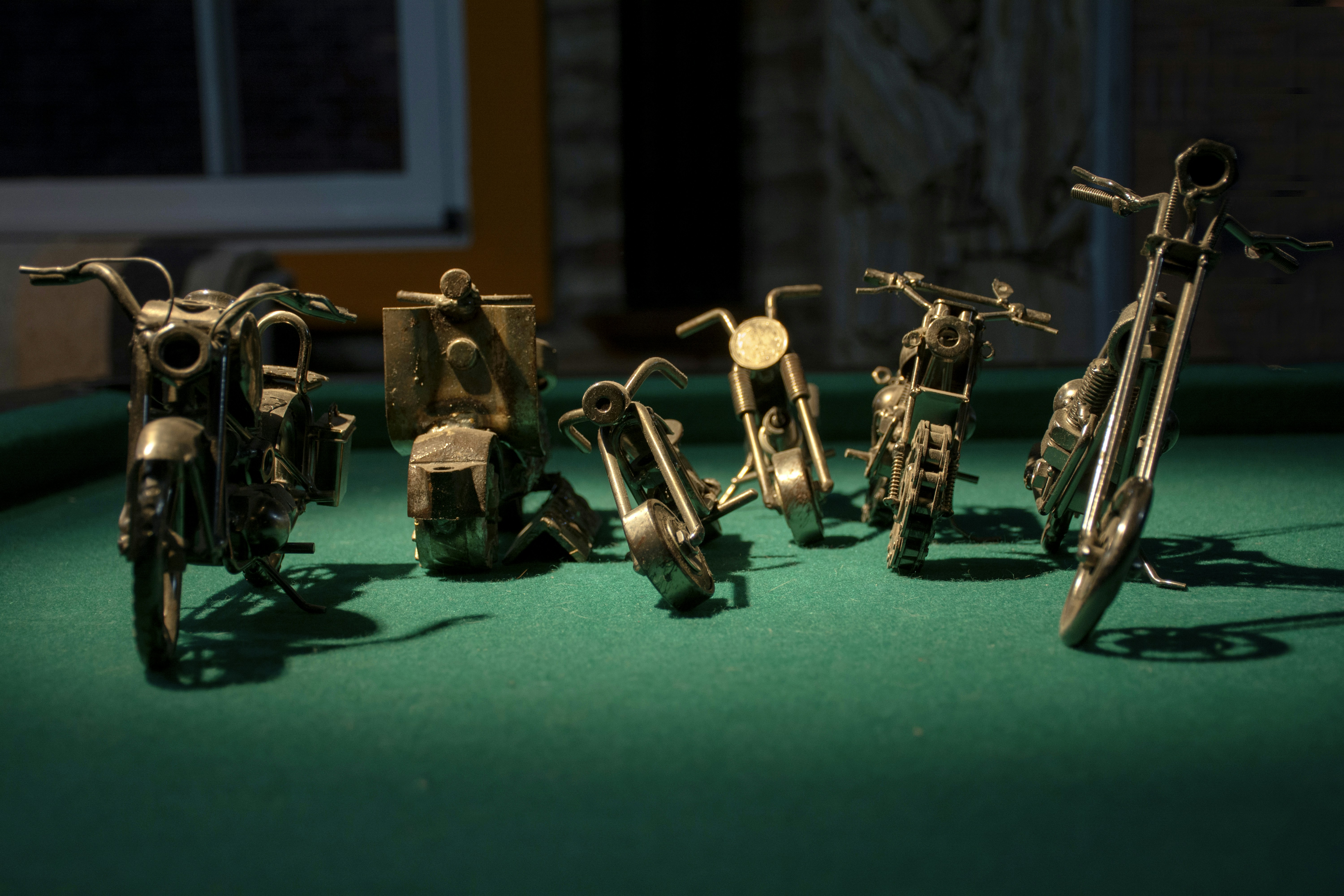 Miniature Night Gallery: Brass Bikes on a Green Stage