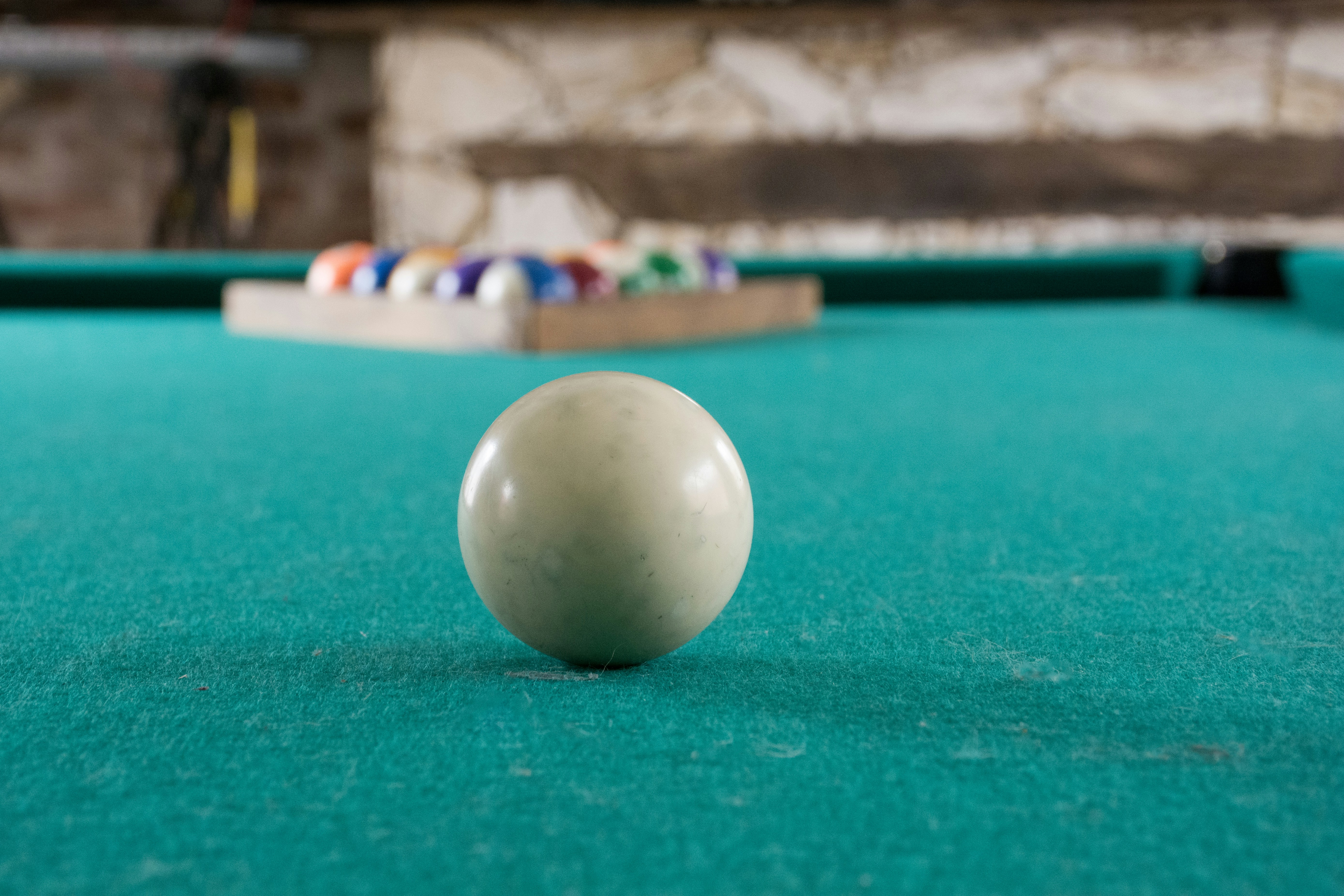 Centered Billiard Ball: A Tangible Moment on a Teal Felt Table