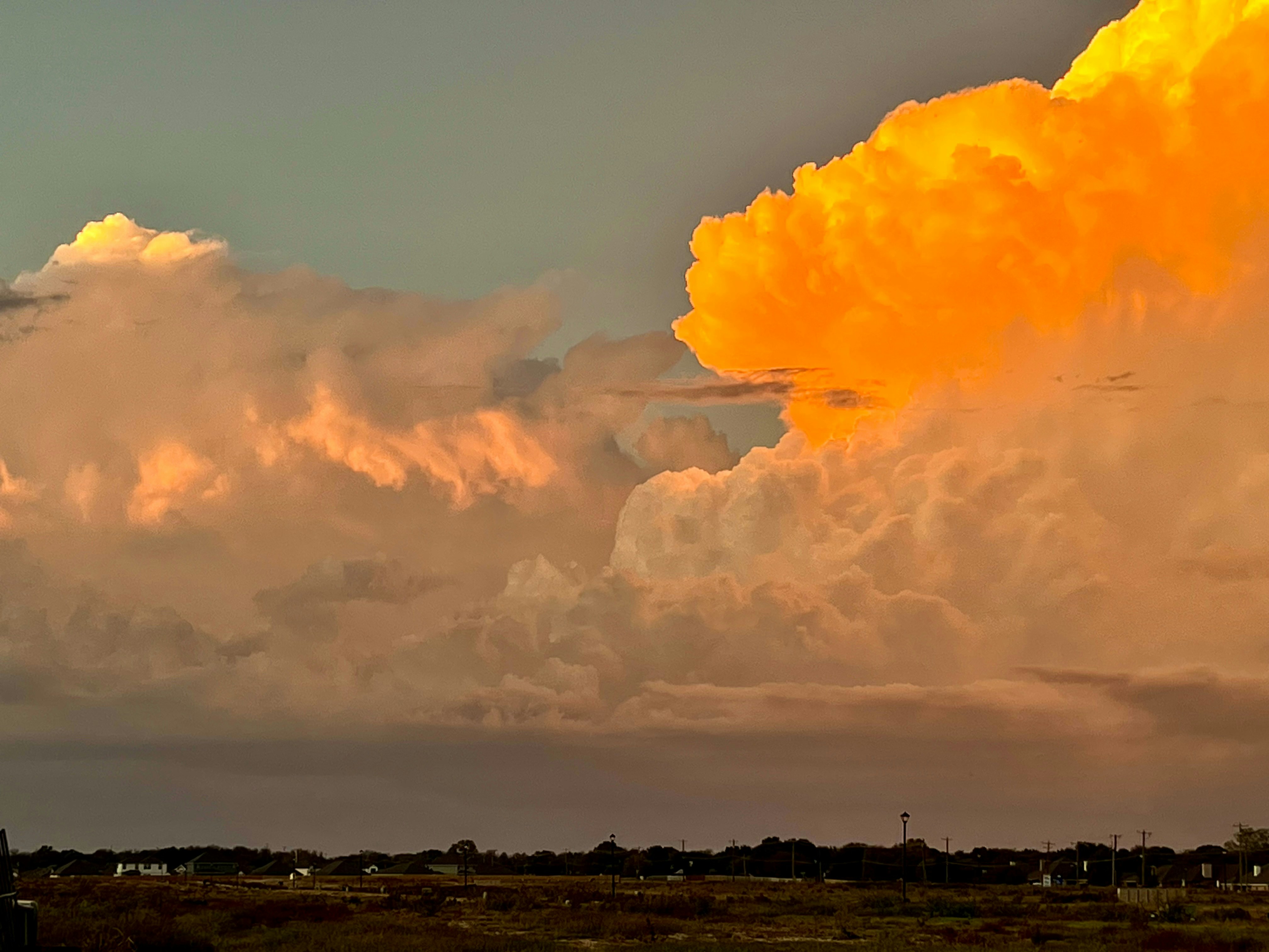 Golden Cloud Arc Over Distant Horizon