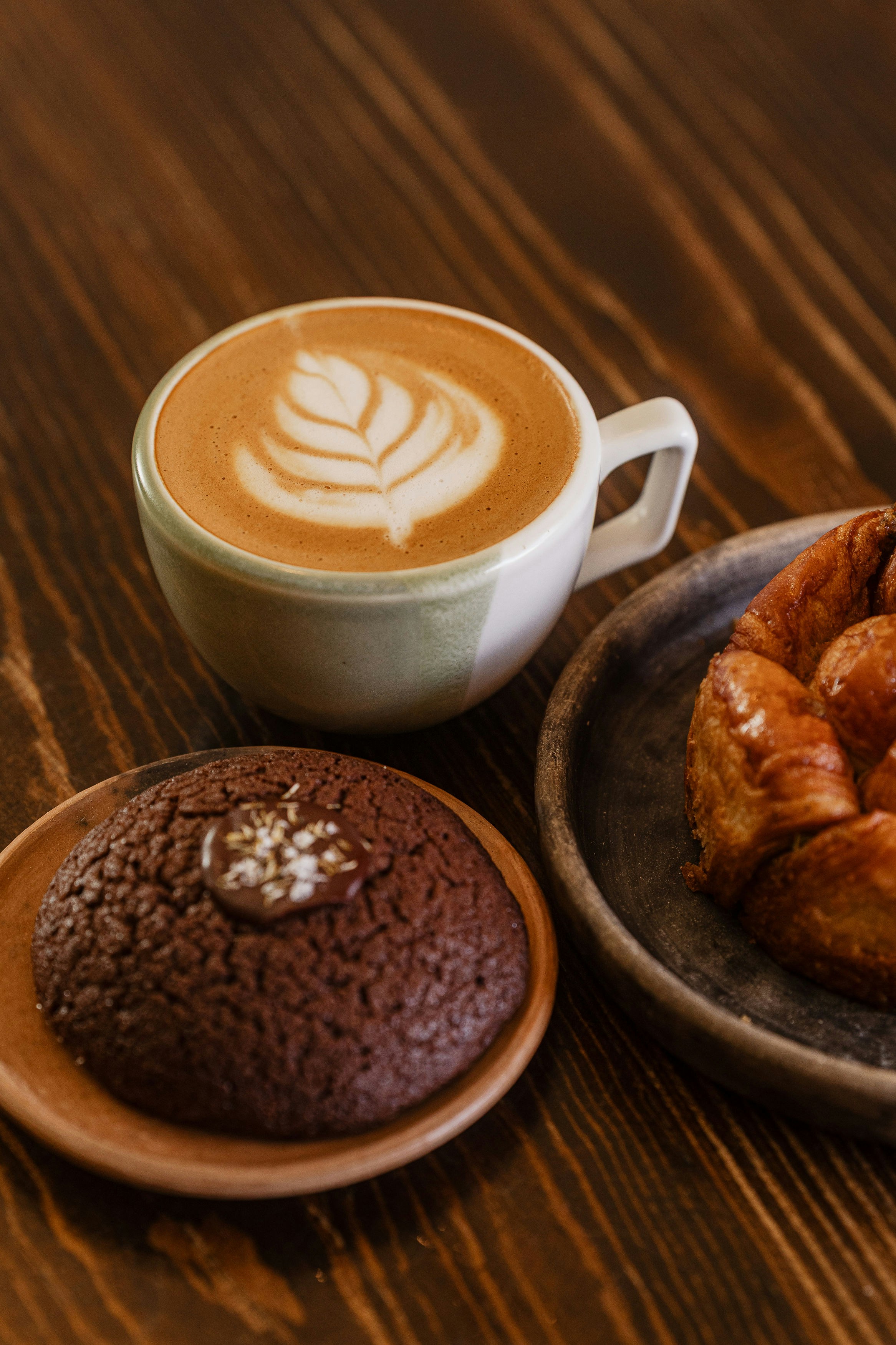 Steaming Espresso Romance: A Latte Leaf Framed by Pastries