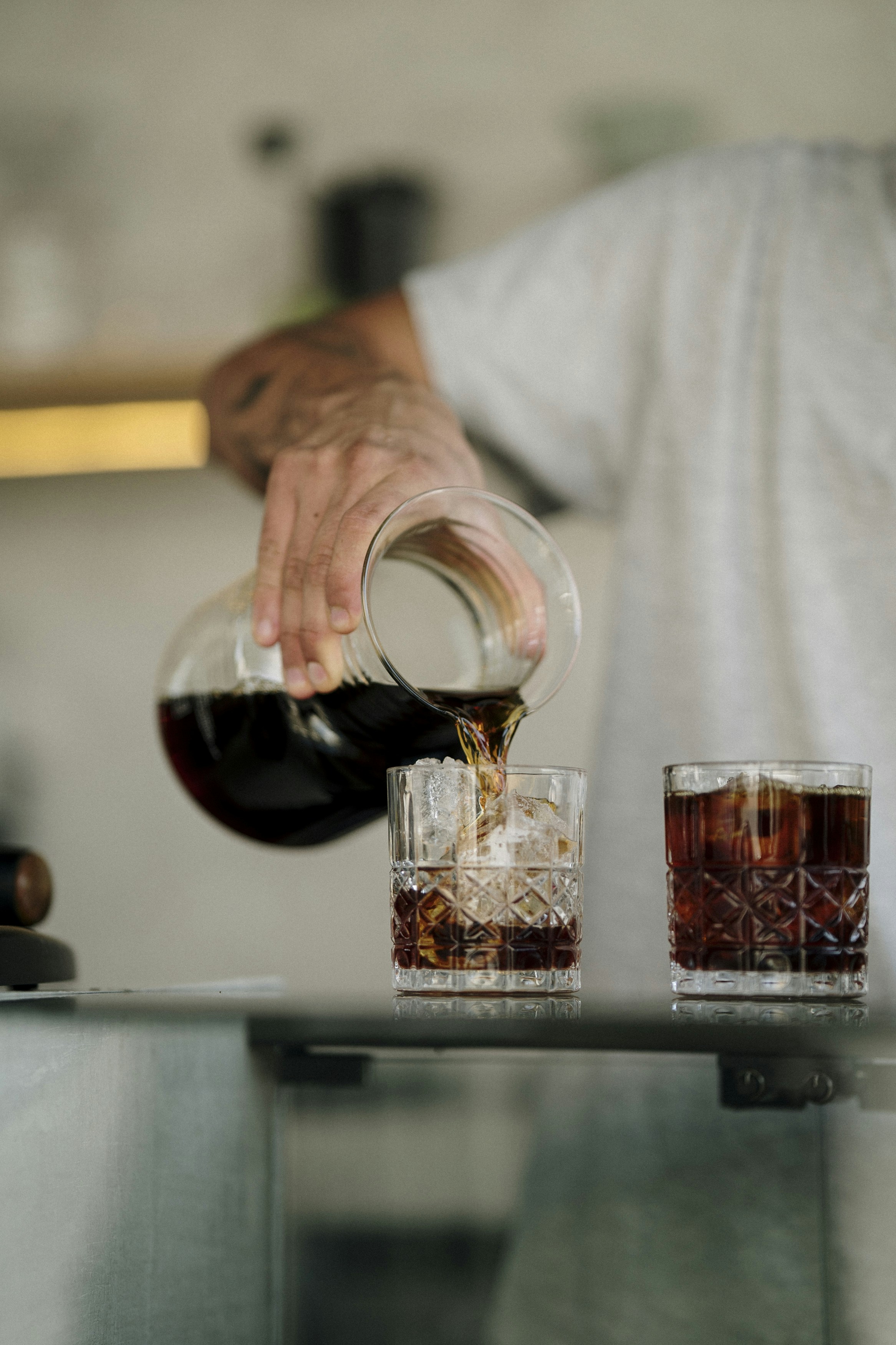 Pouring patience: a bartender’s quiet ritual over crystal old-fashioned glasses