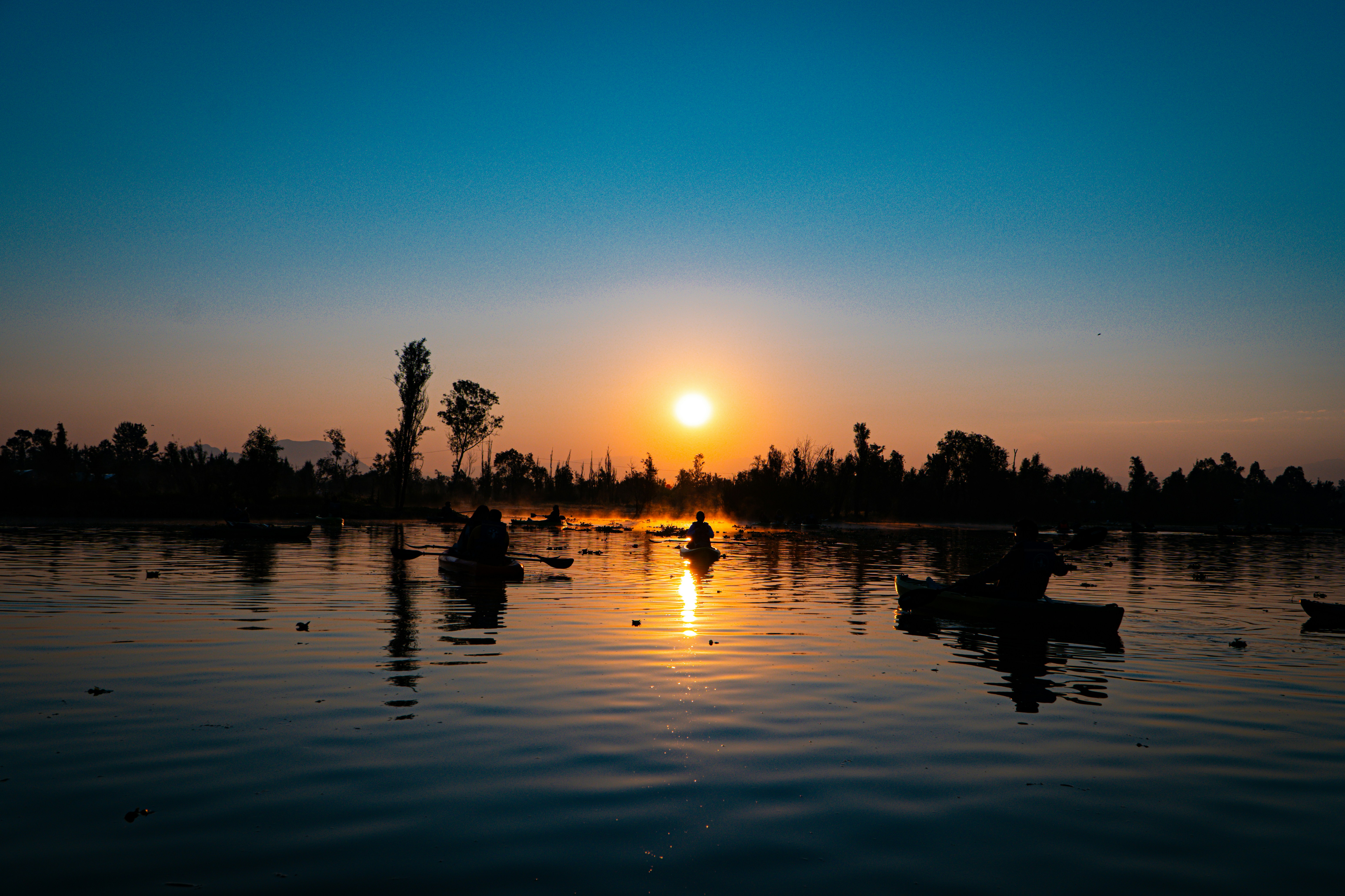 Sunlit Silence: Boats Drifting at Dusk