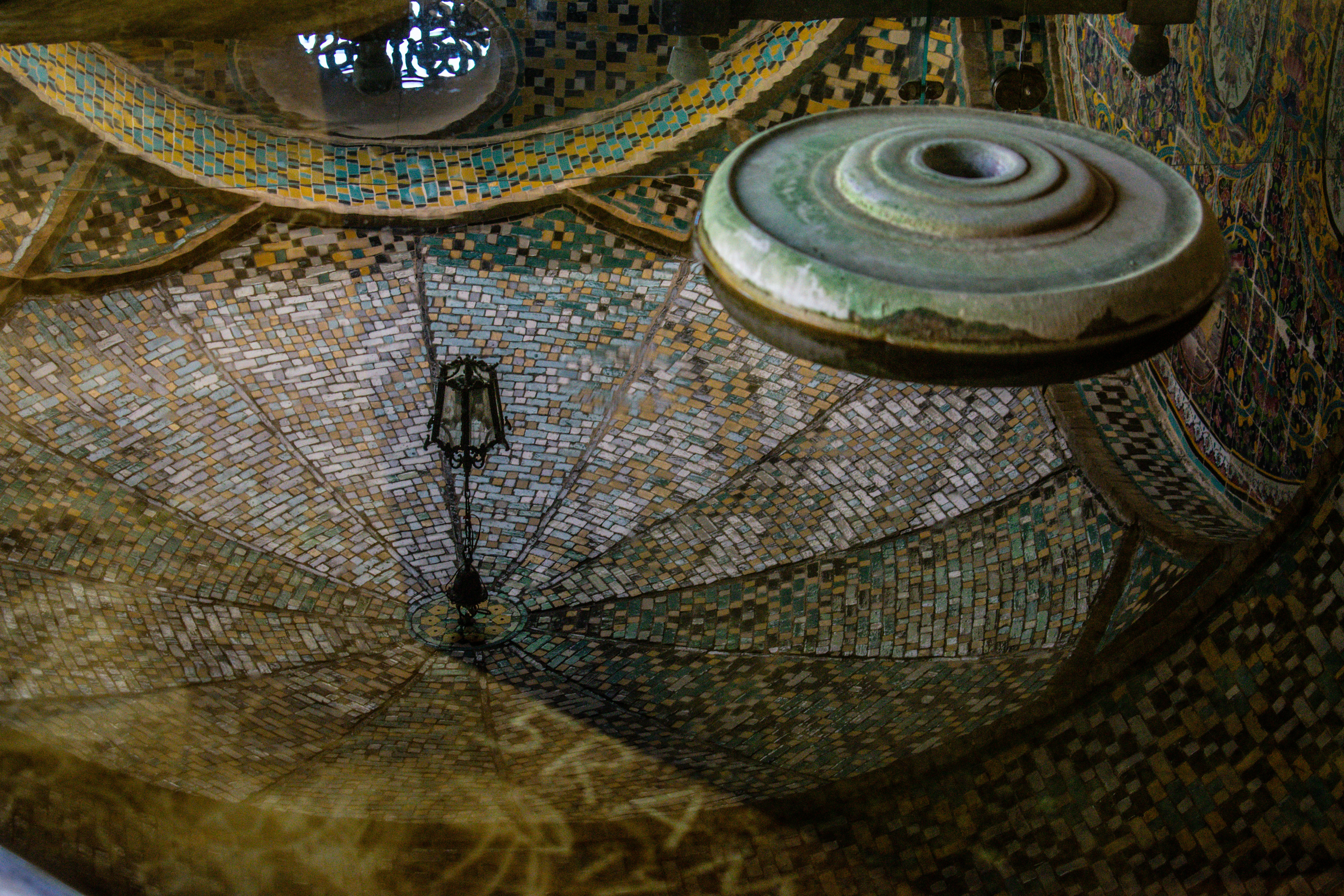 Whorled Mosaic Vault: A Surreal Ceiling Under a Suspended Vessel