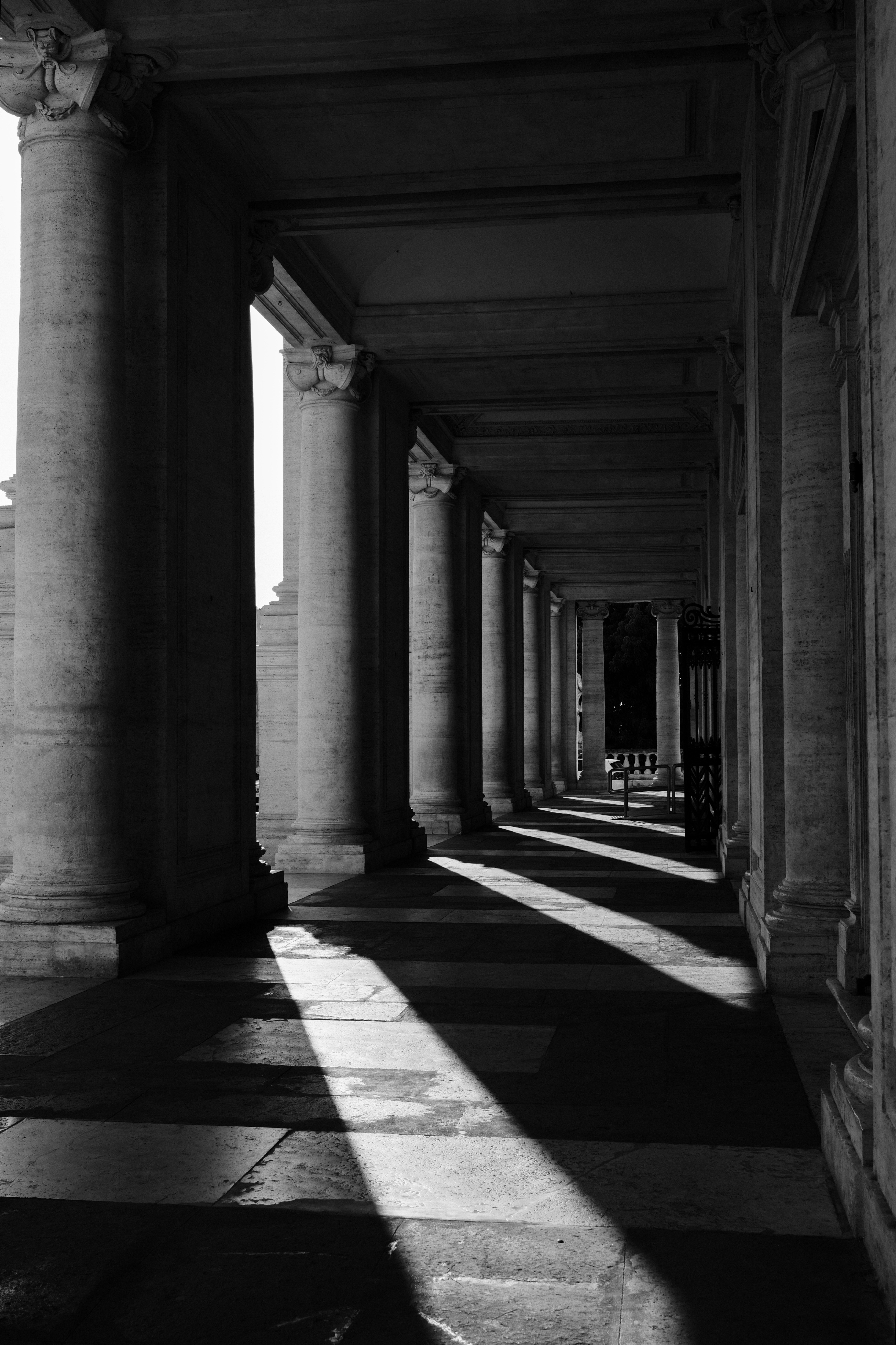 Shadowed Colonnade: Light Slashes Through the Arcade