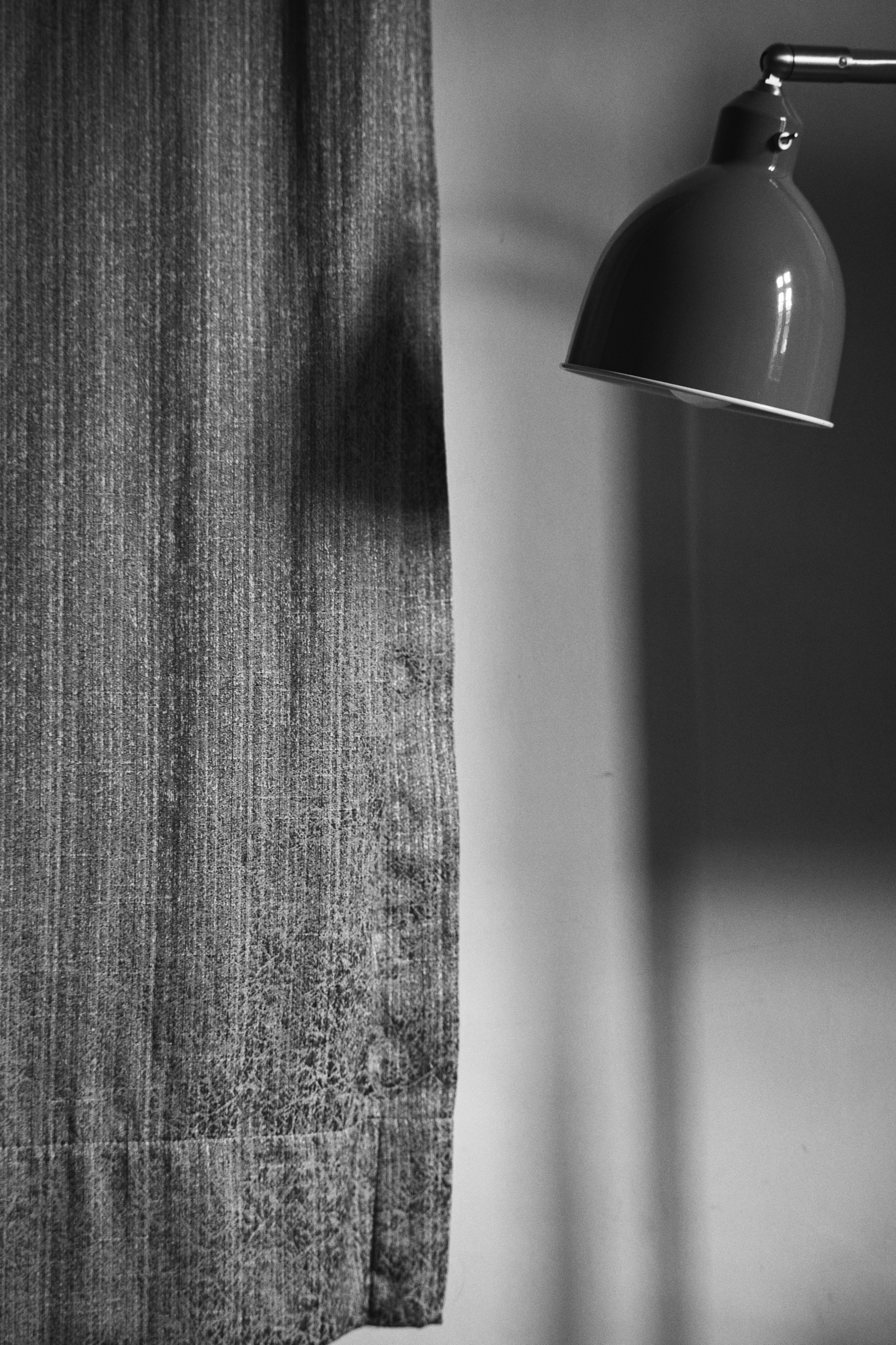 Contrasting Shade: A Lamp Casts Its Quiet Light on Weathered Wood