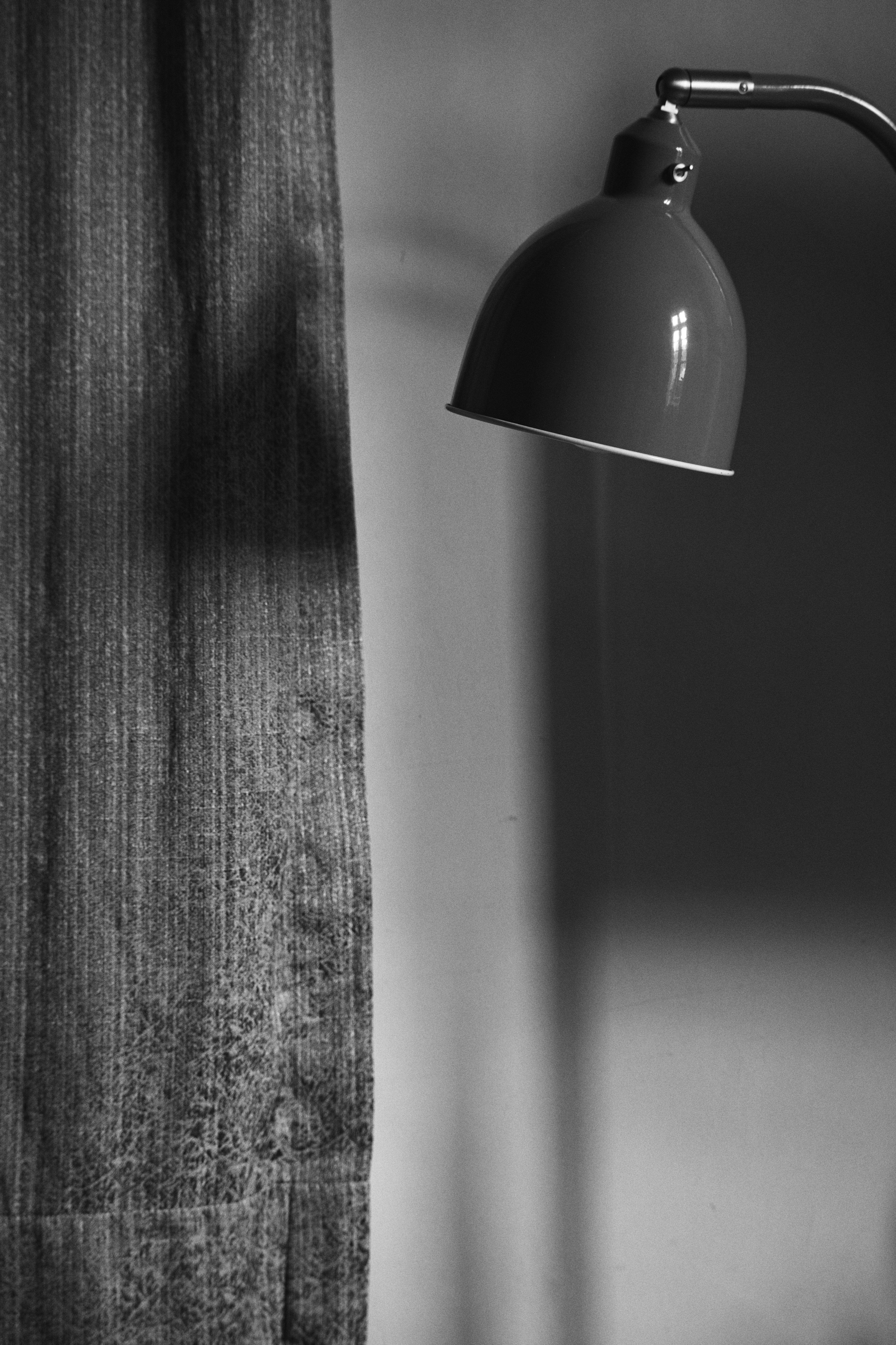 Focused Glow: A Desk Lamp Halts Time by the Curtain
