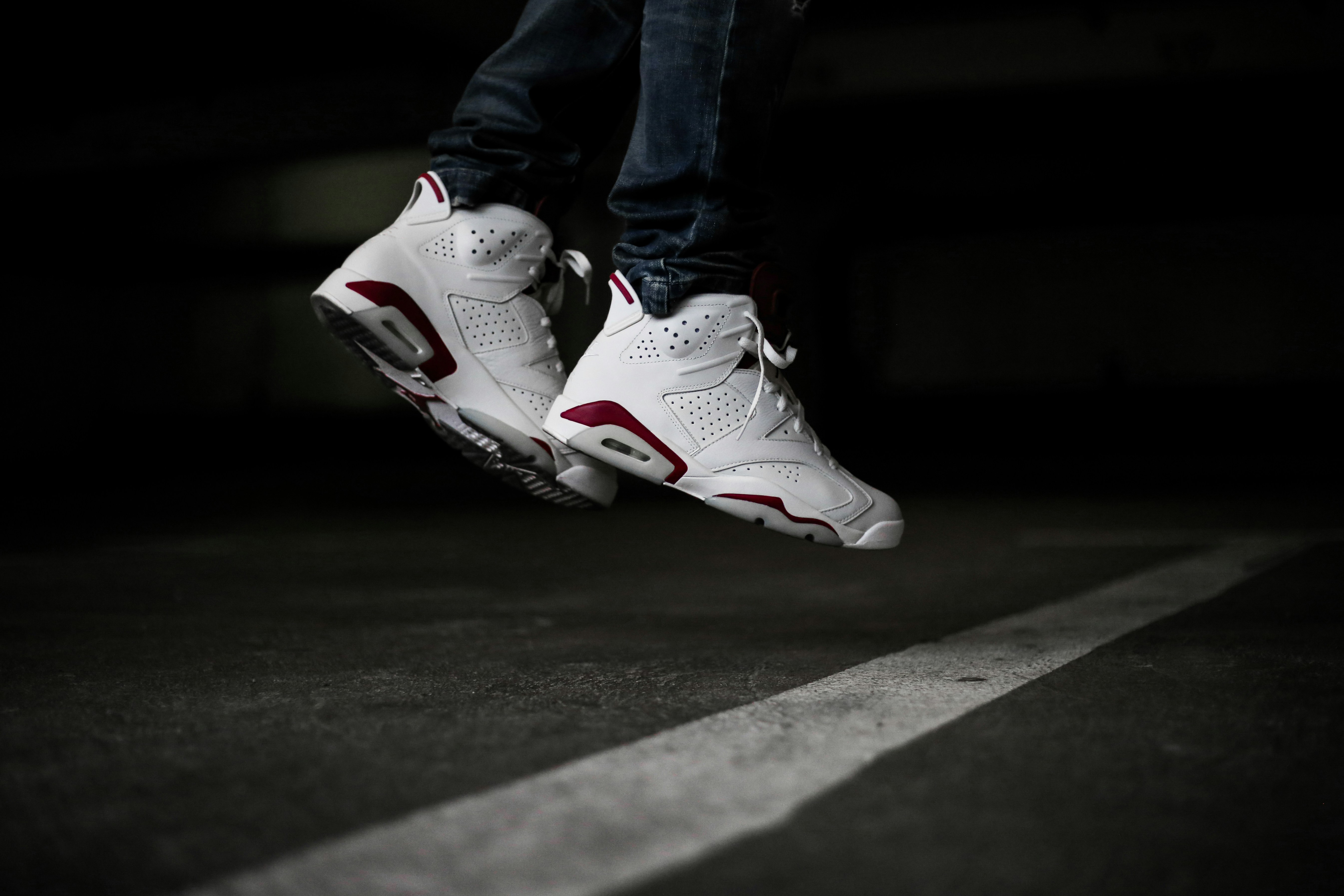 Levitate in White and Scarlet: Sneakers Hover Over a Painted Line