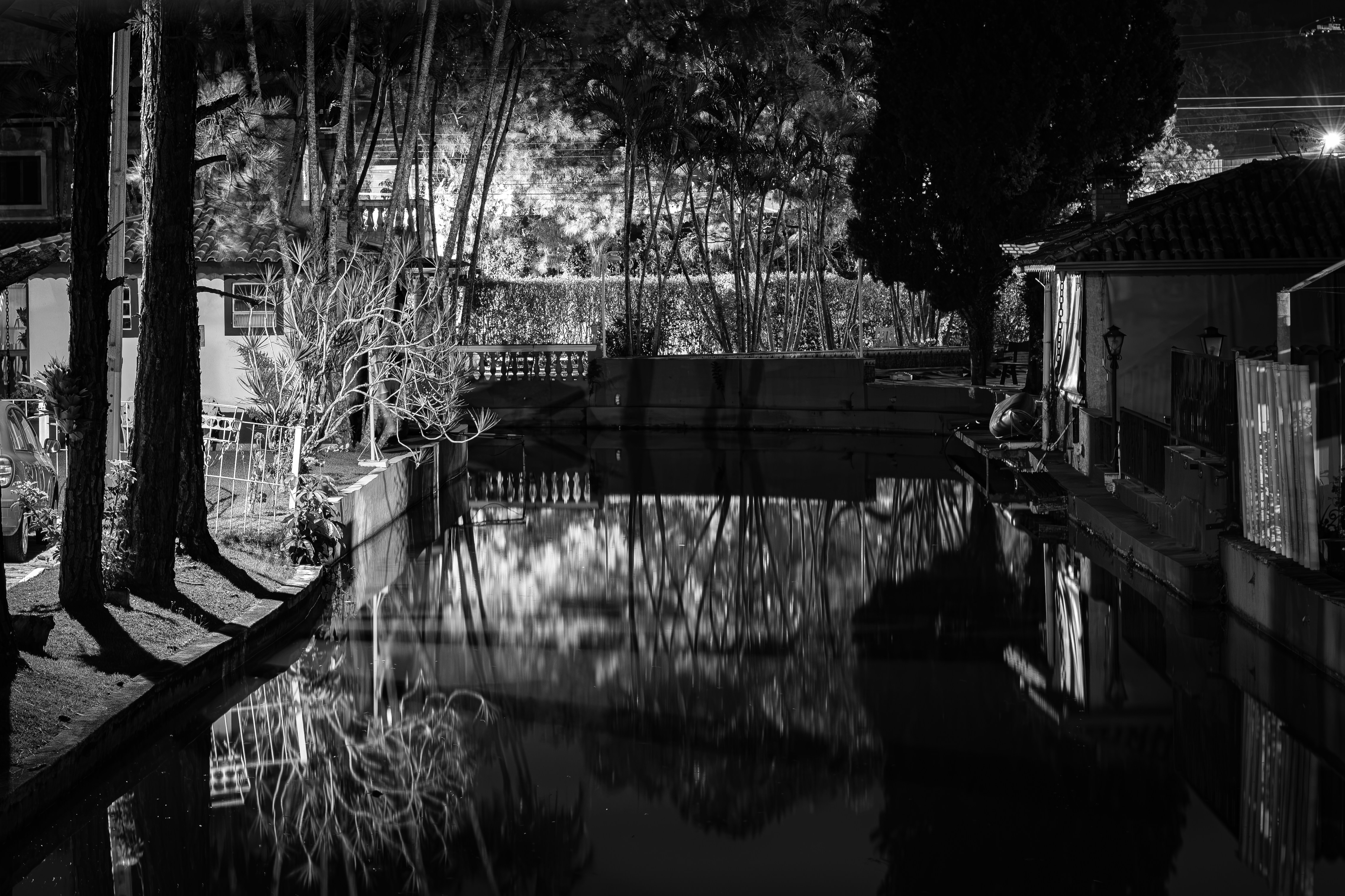 Moonlit Canal Reflections Behind the Quiet Fence
