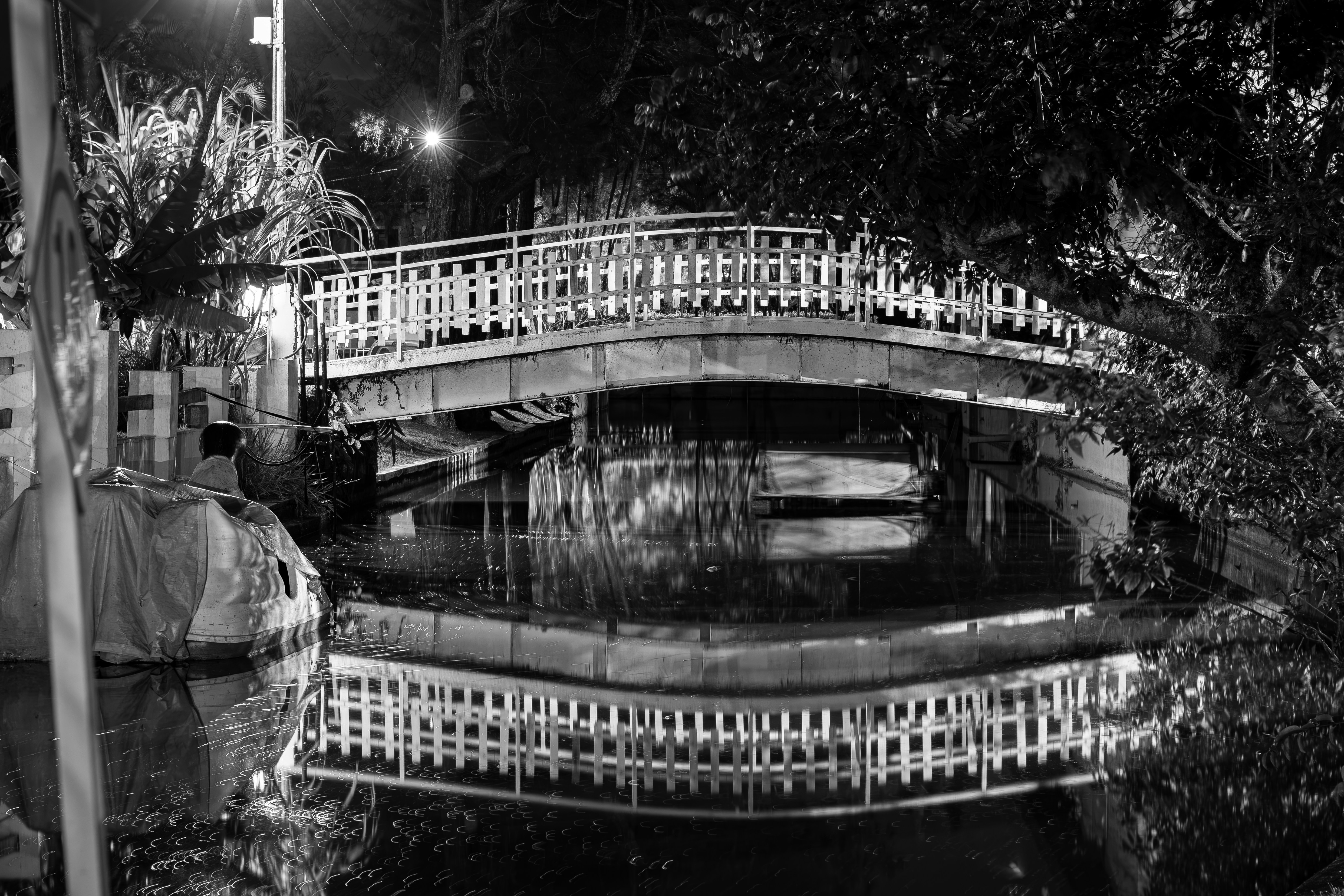 Moonlit Canal: Reflections Under the Pedestrian Bridge