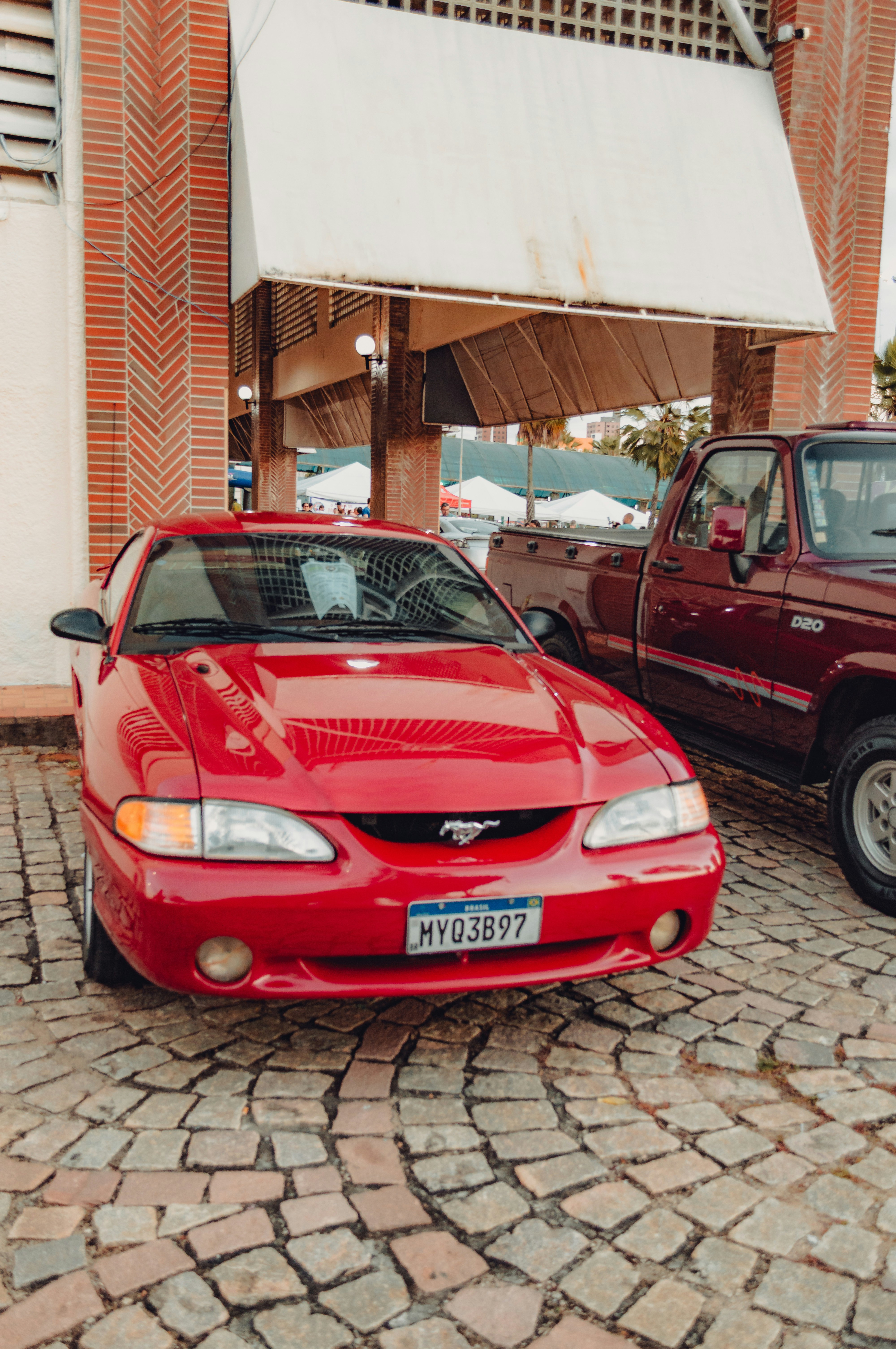 Red Mustang in a Brick-arcade Courtyard