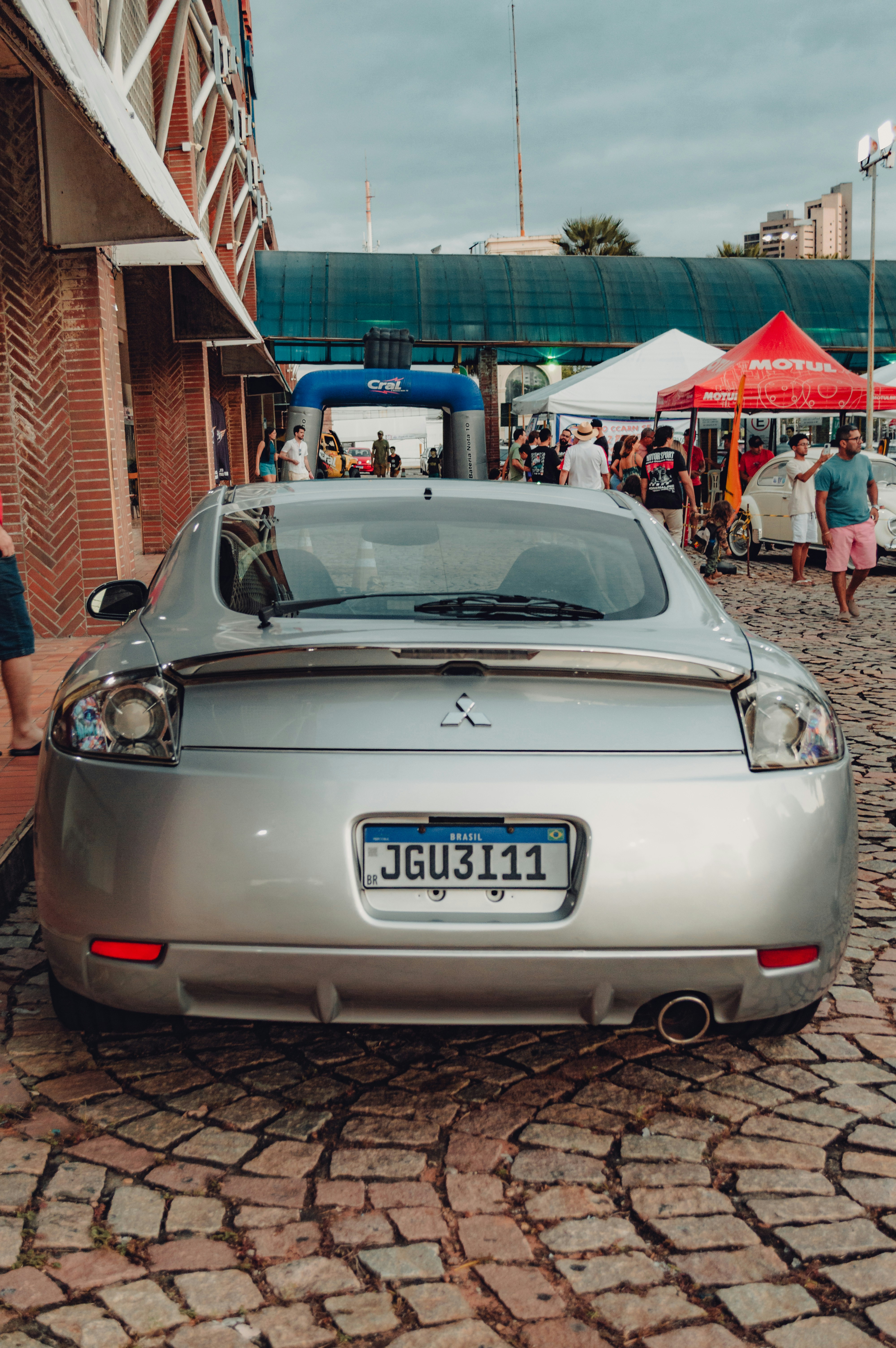 Midday Meet: The Silver Mitsubishi Amid Cobbled Promenade