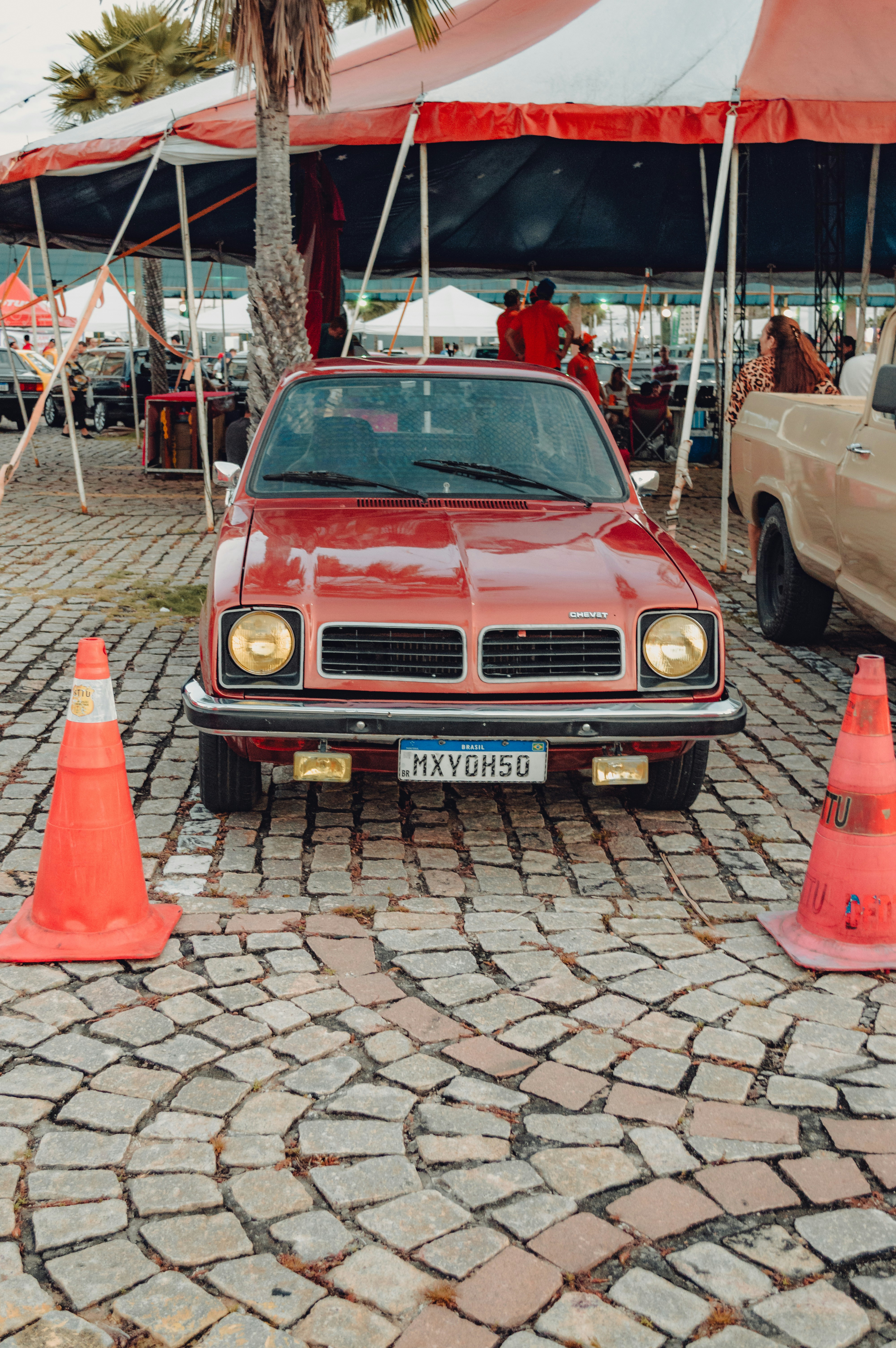 Red Classic in a Cobblestone Corridor