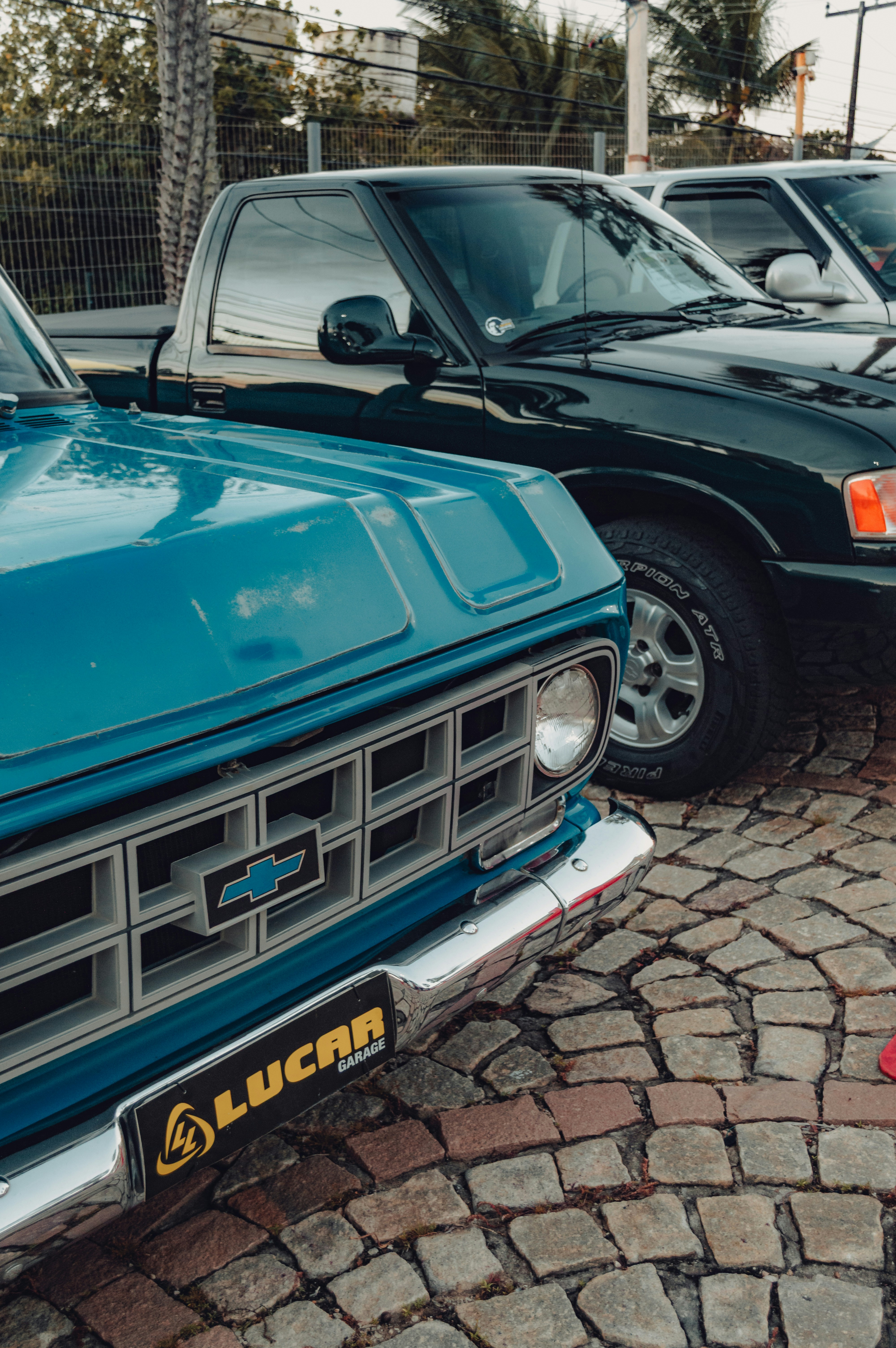 Blue Chevrolet Frontier Grille in a Row of Vintage Trucks