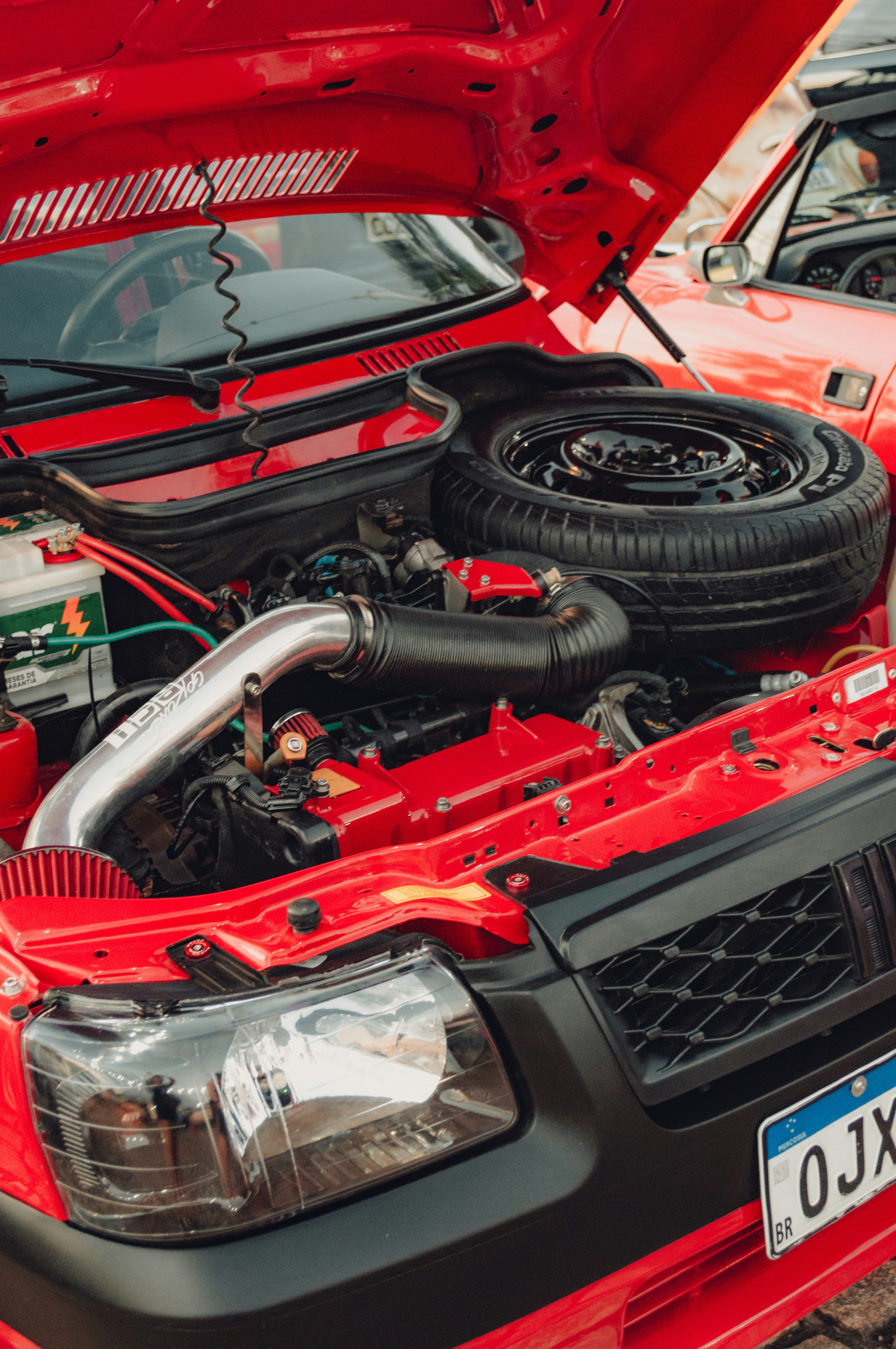 Under the Hood: A Bright Red Classic with Spares and Spare Tire View
