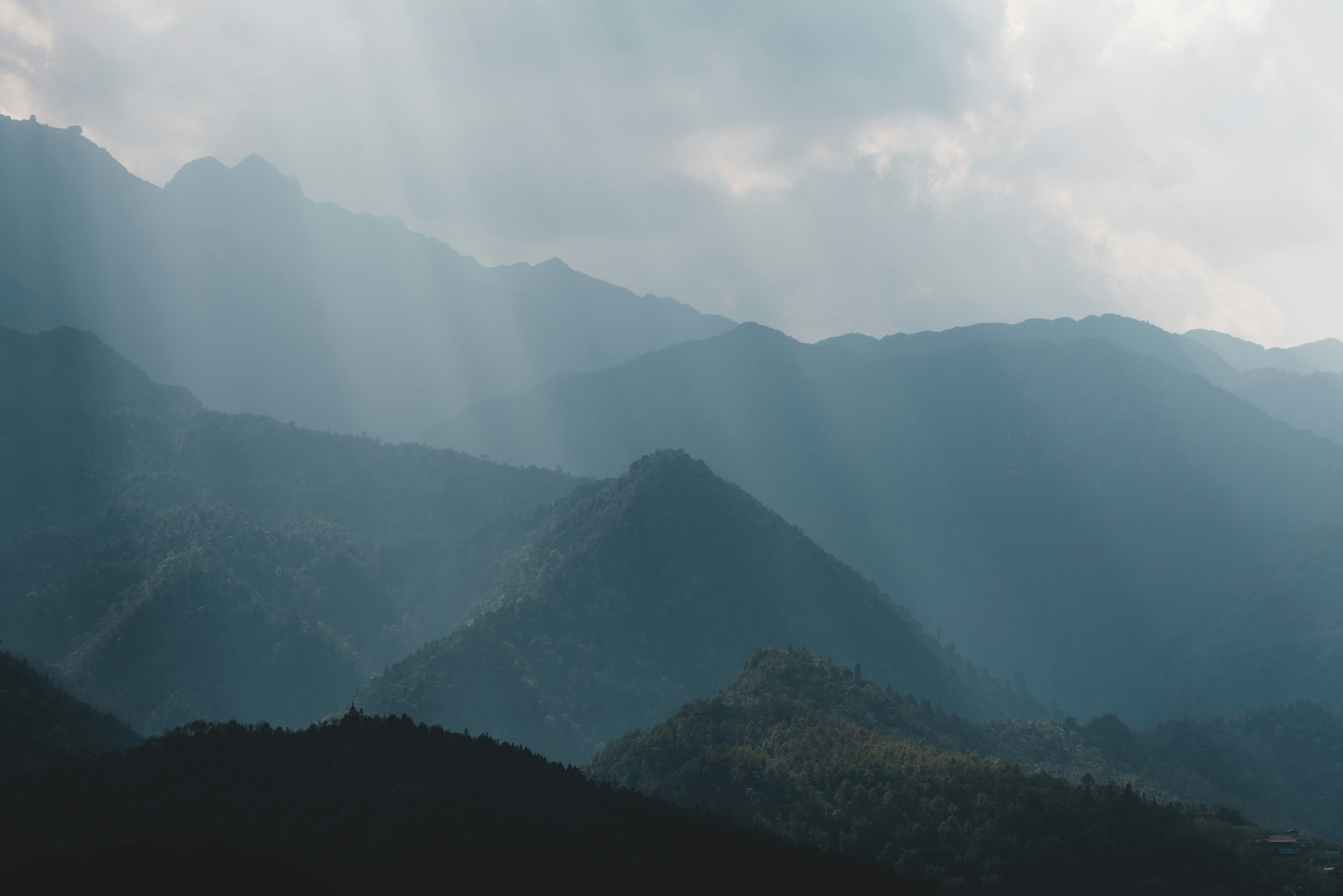 Rays Through the Mist: Ridge Line Silhouettes Across the Valley