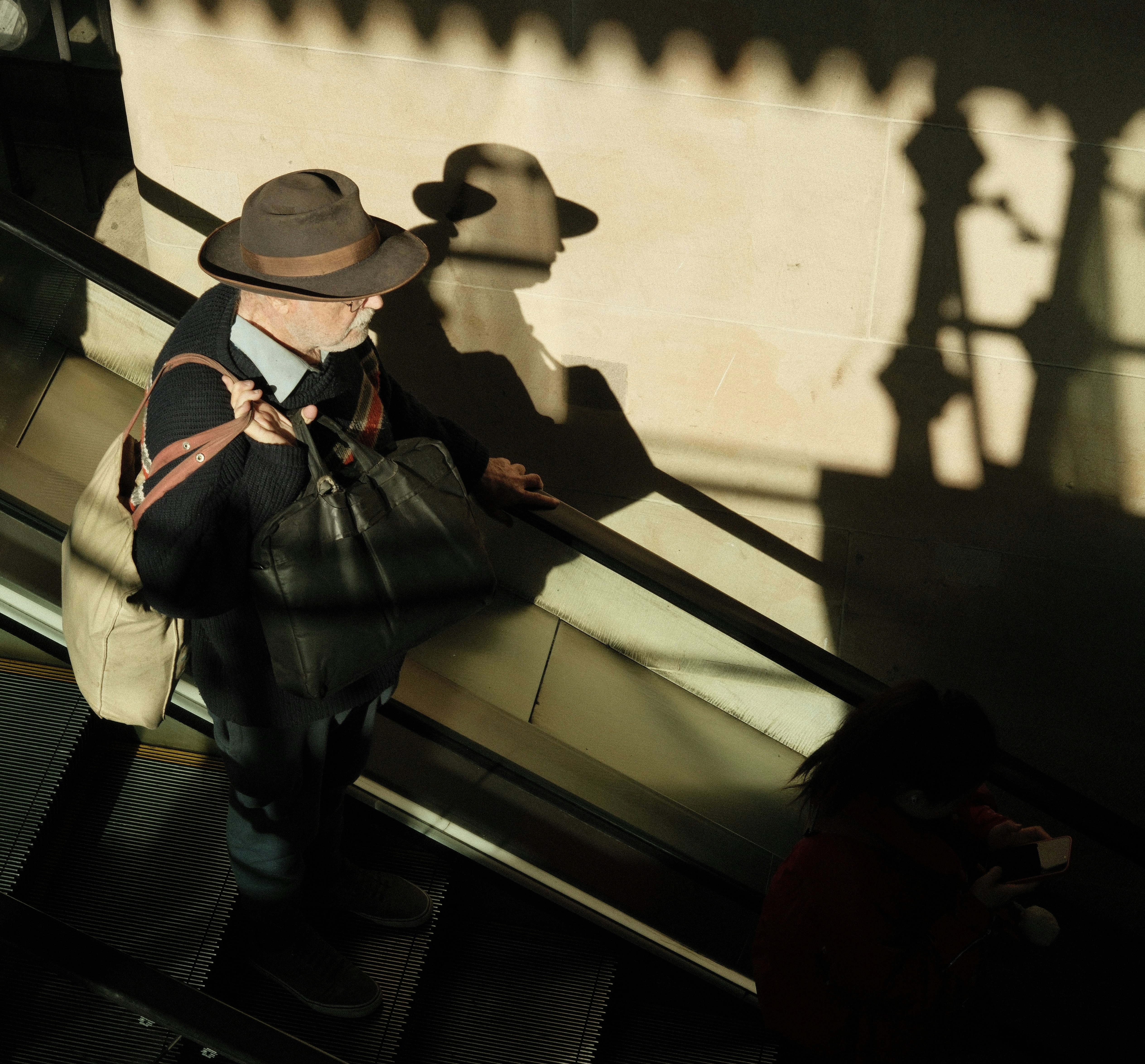 Shadowed Figure on the Escalator: A Glimpse of Quiet Motion