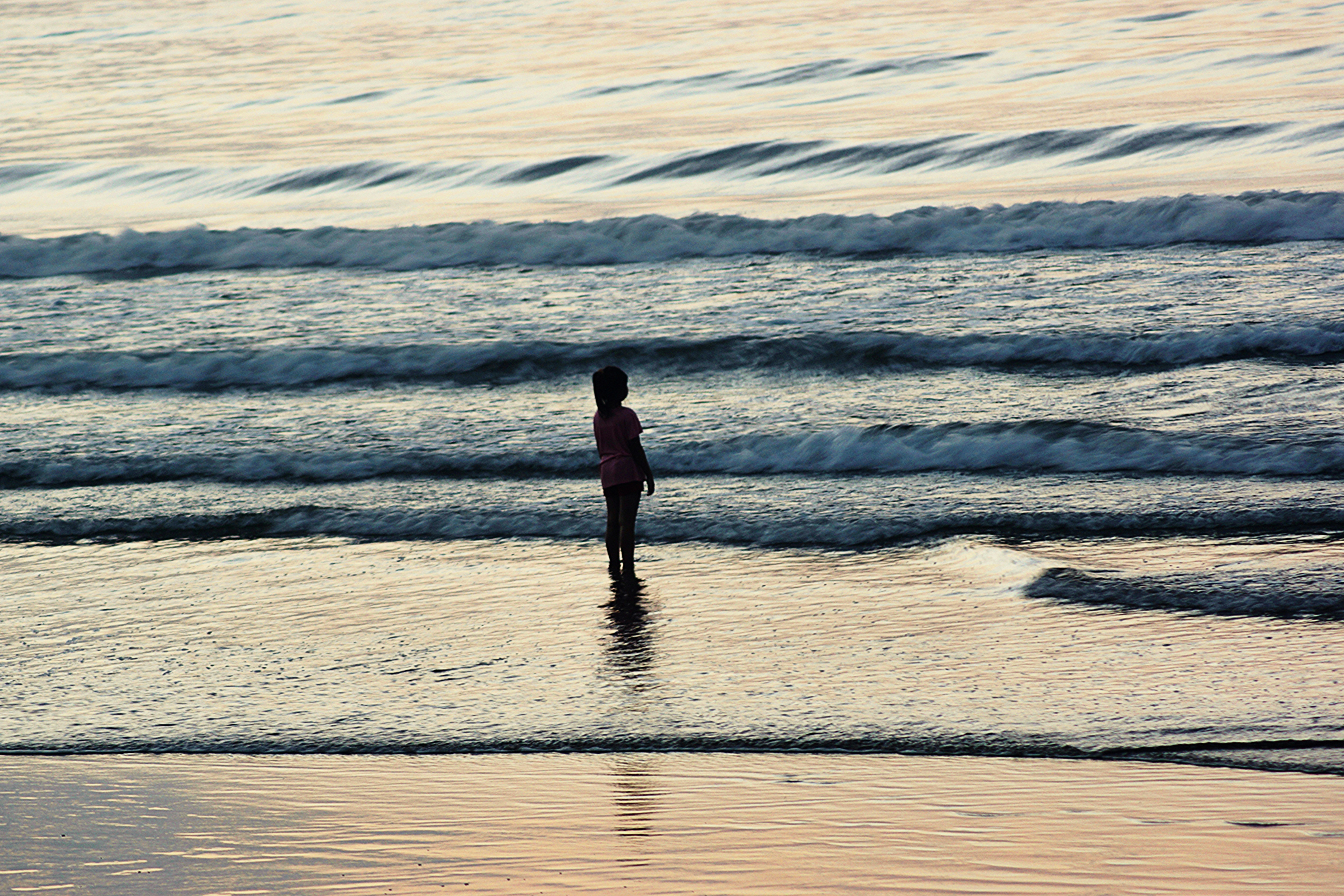Solitary silhouette at the shoreline at dusk
