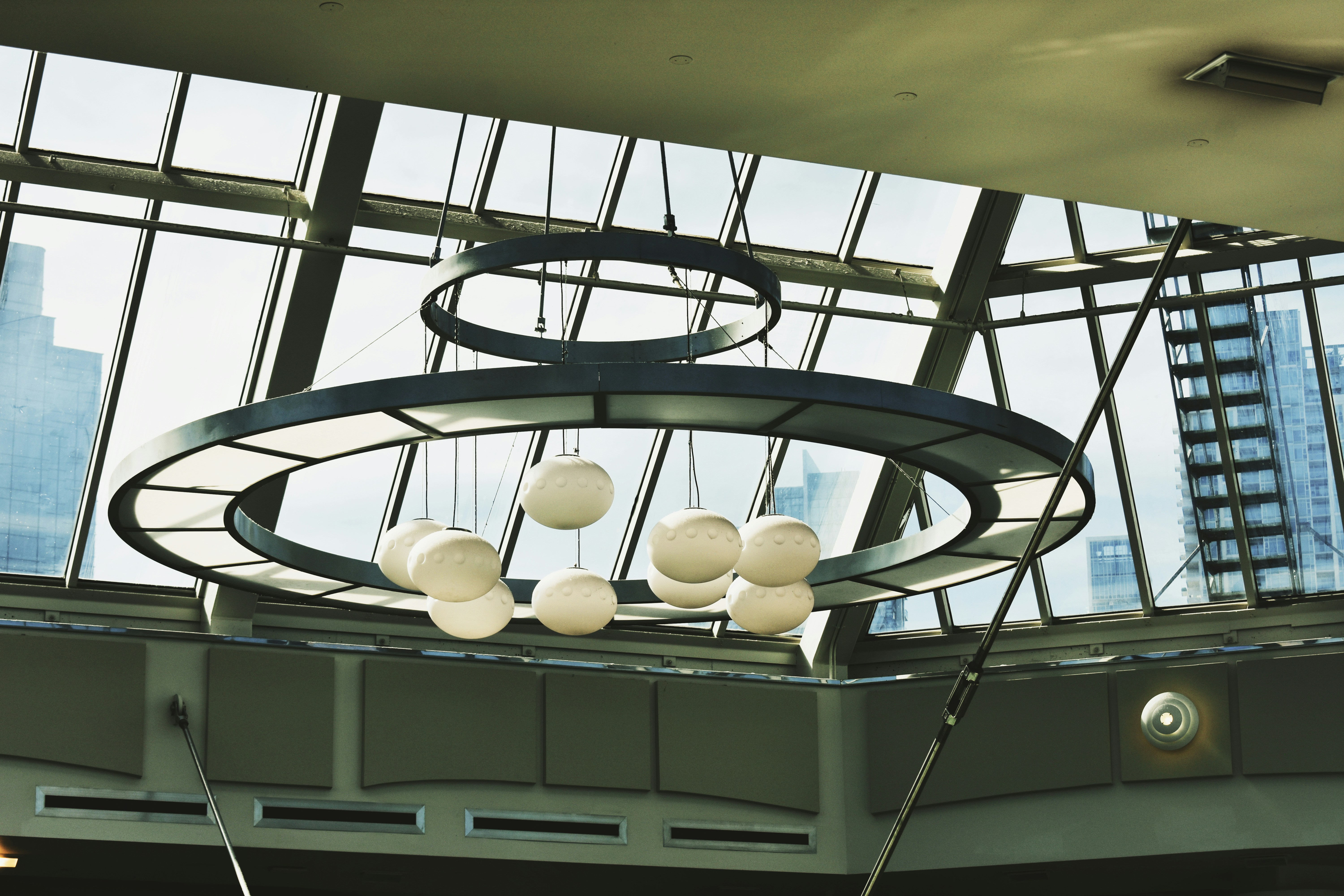 Orbital Ring Lights Hovering Over a Modern Atrium