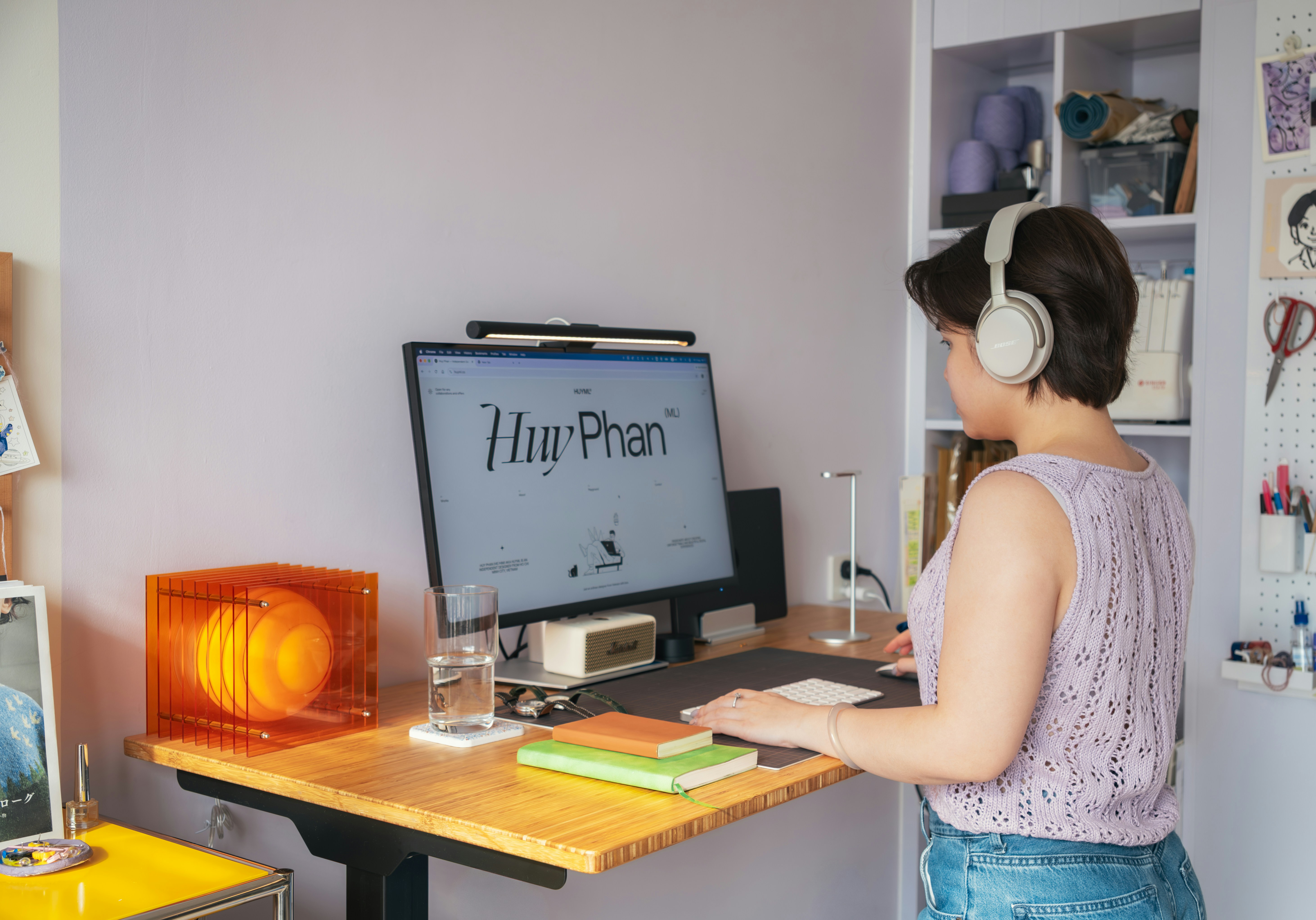 Studio Focus: Designer at a Quiet Desk with Headphones and Computer