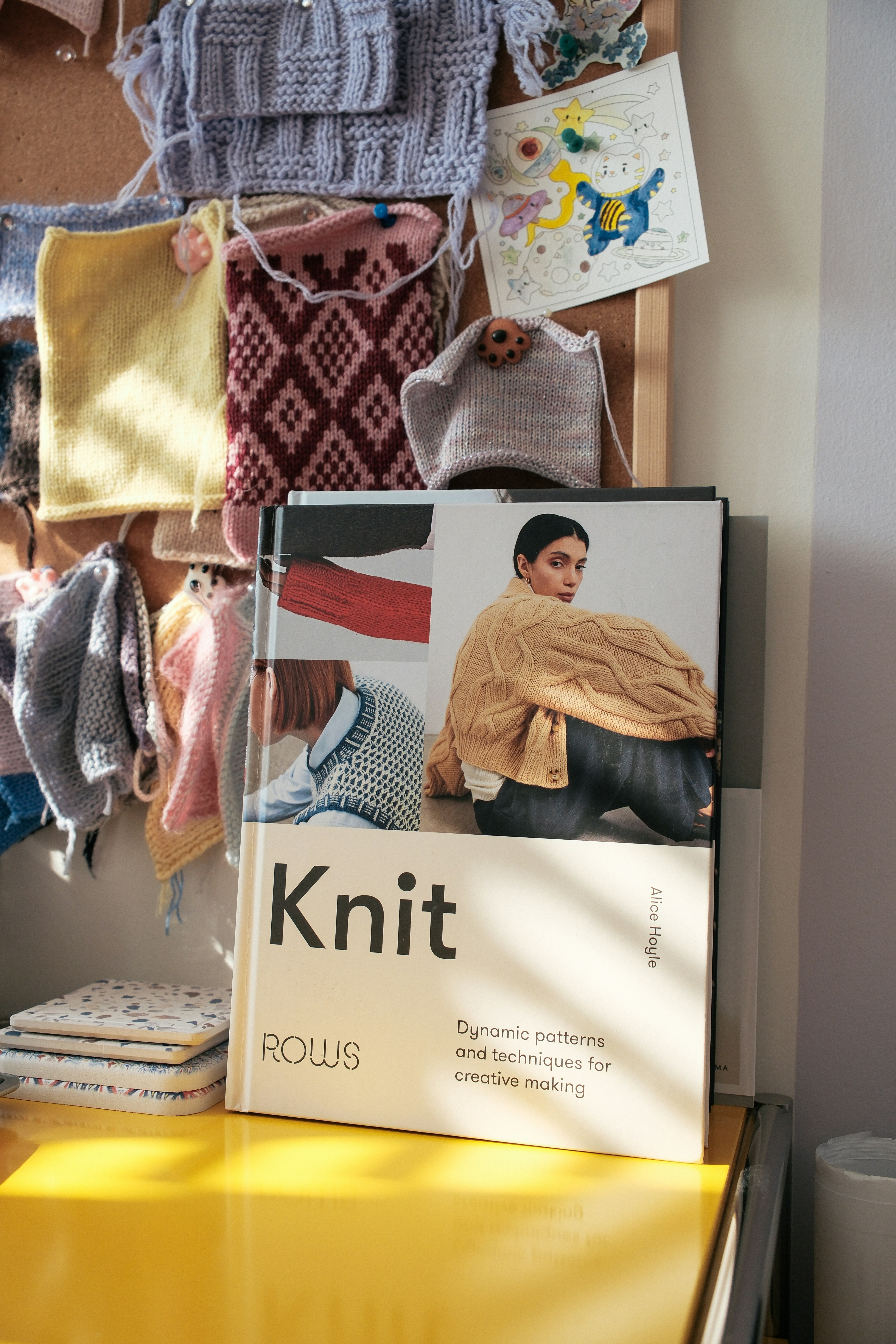 Knit and Cozy: A Colored Tapestry of Handmade Warmth Surrounds a Knit Book