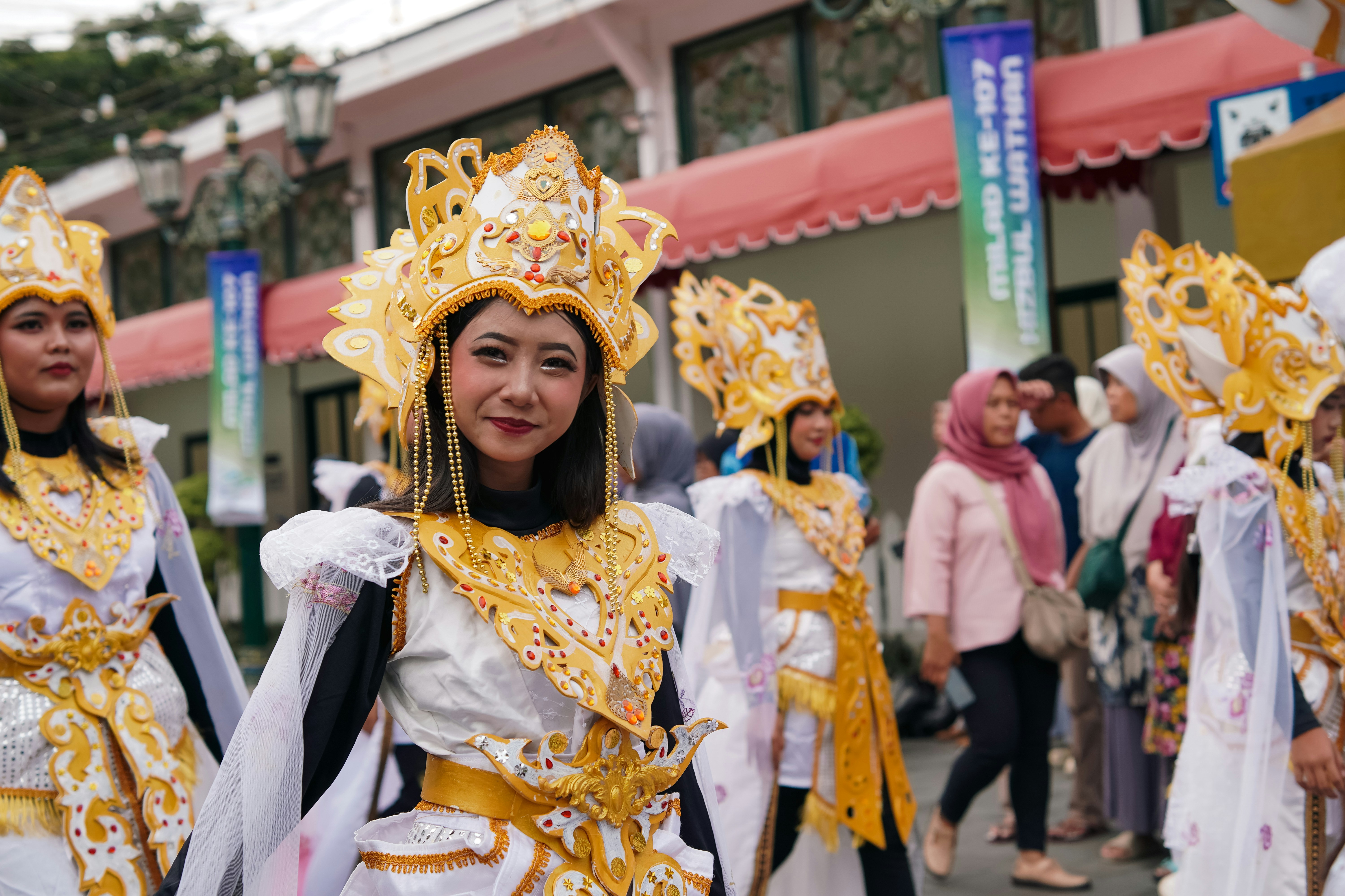Golden carnival queen leads a cheerfully ornate procession
