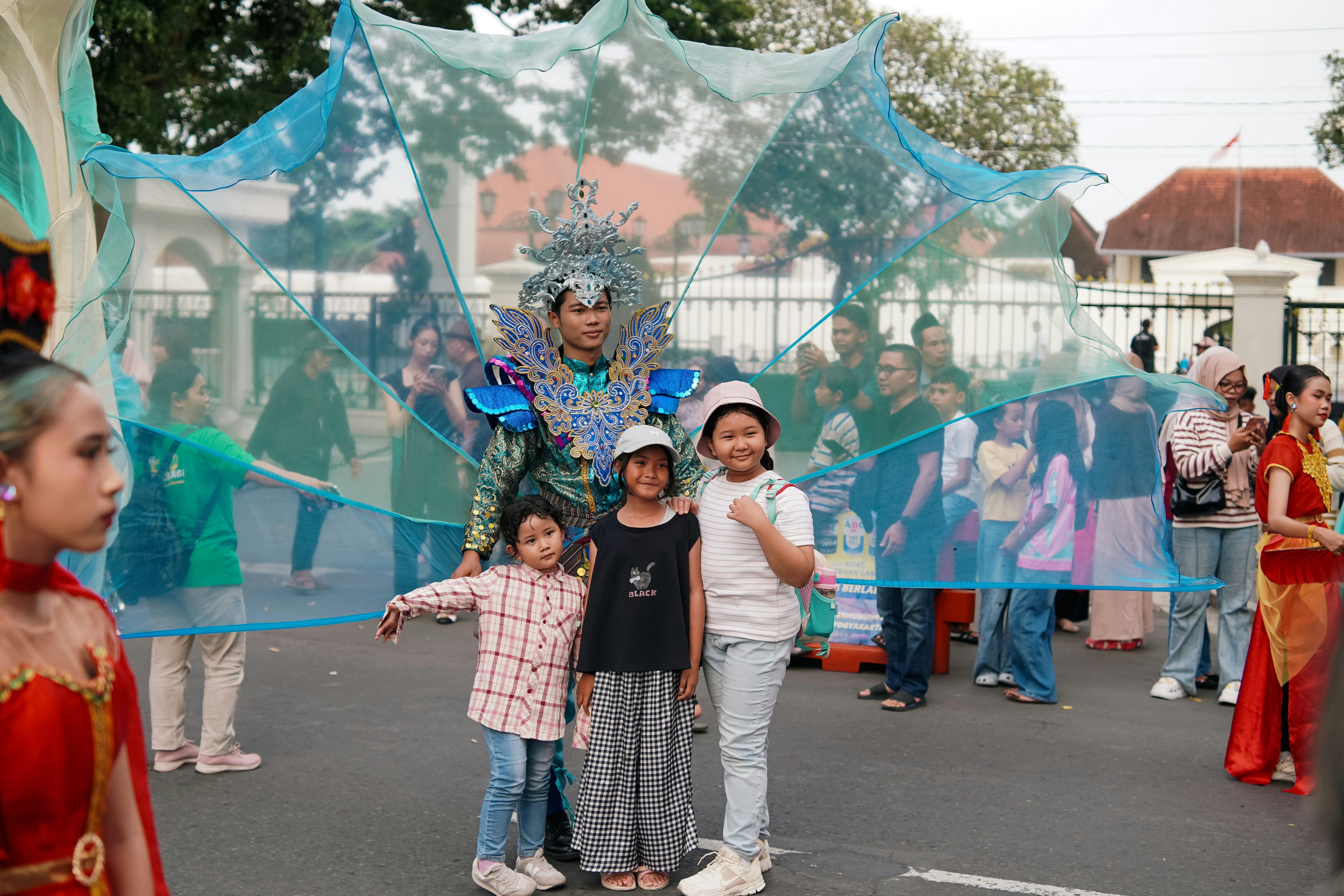 Masked Performer with Enchanted Net Weave Frames a Family Moment