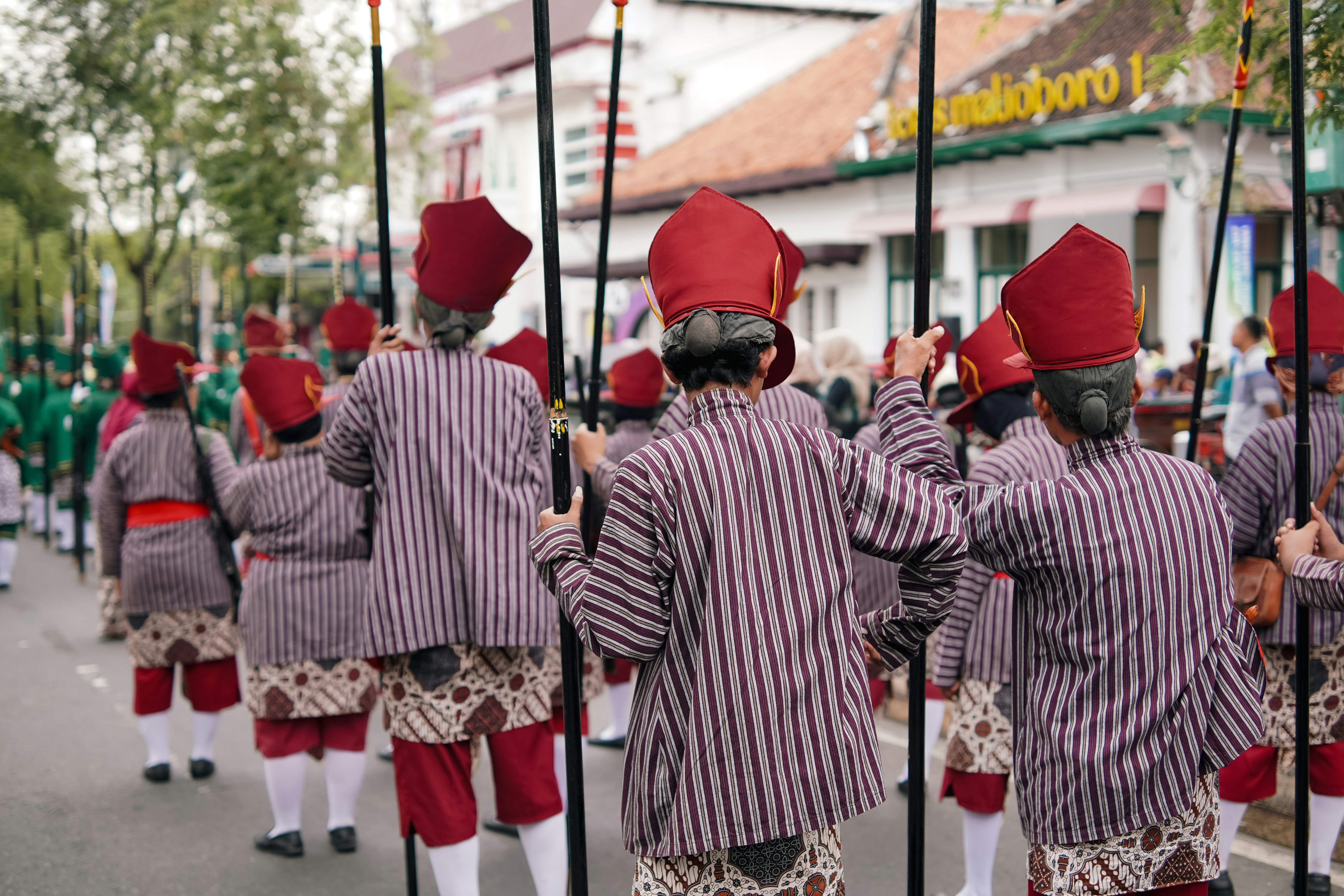 Red-Striped Parade: A Close-Knit Moment in a City Street