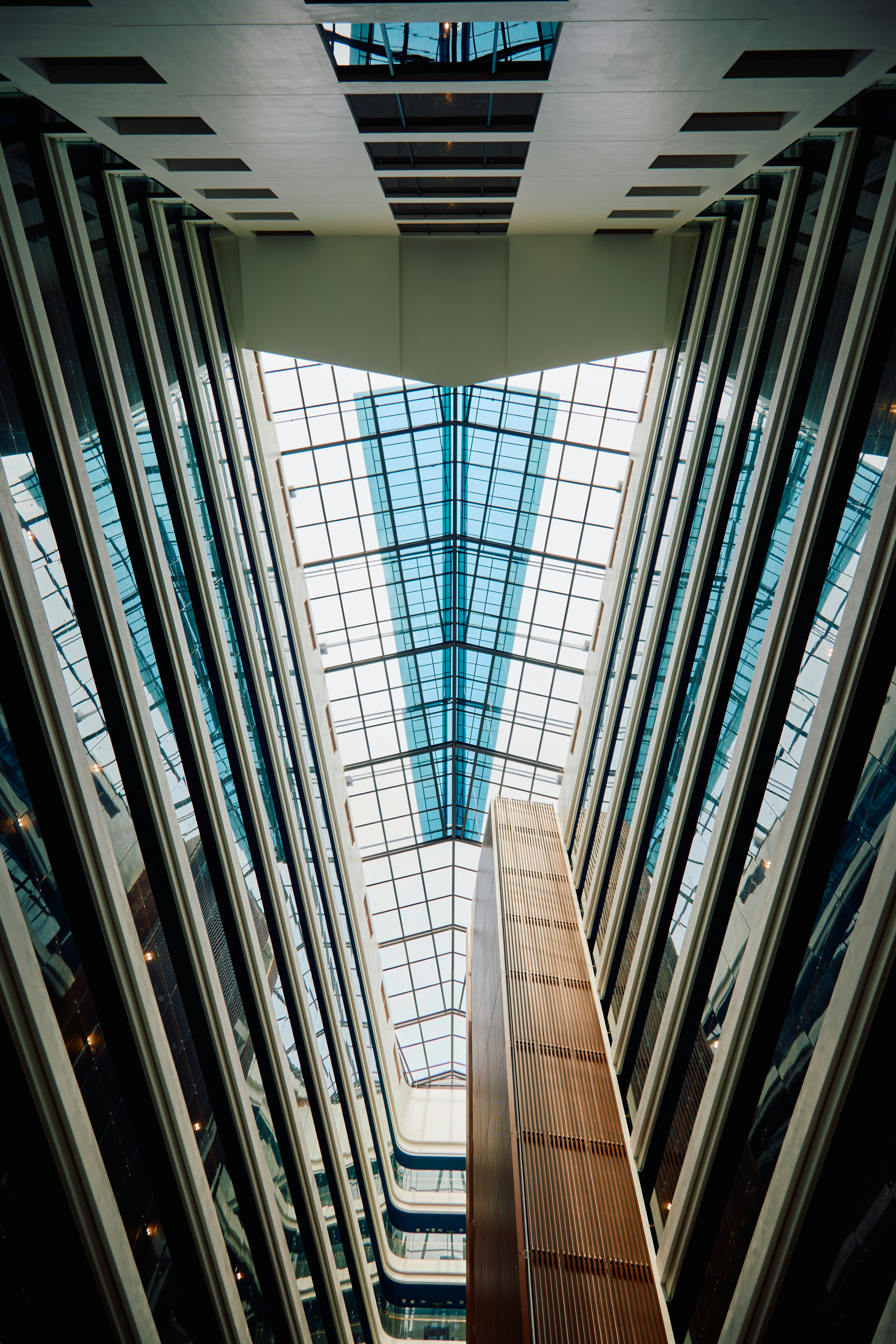 Architectural Vantage: A Vertical Atrium with Glass and Steel