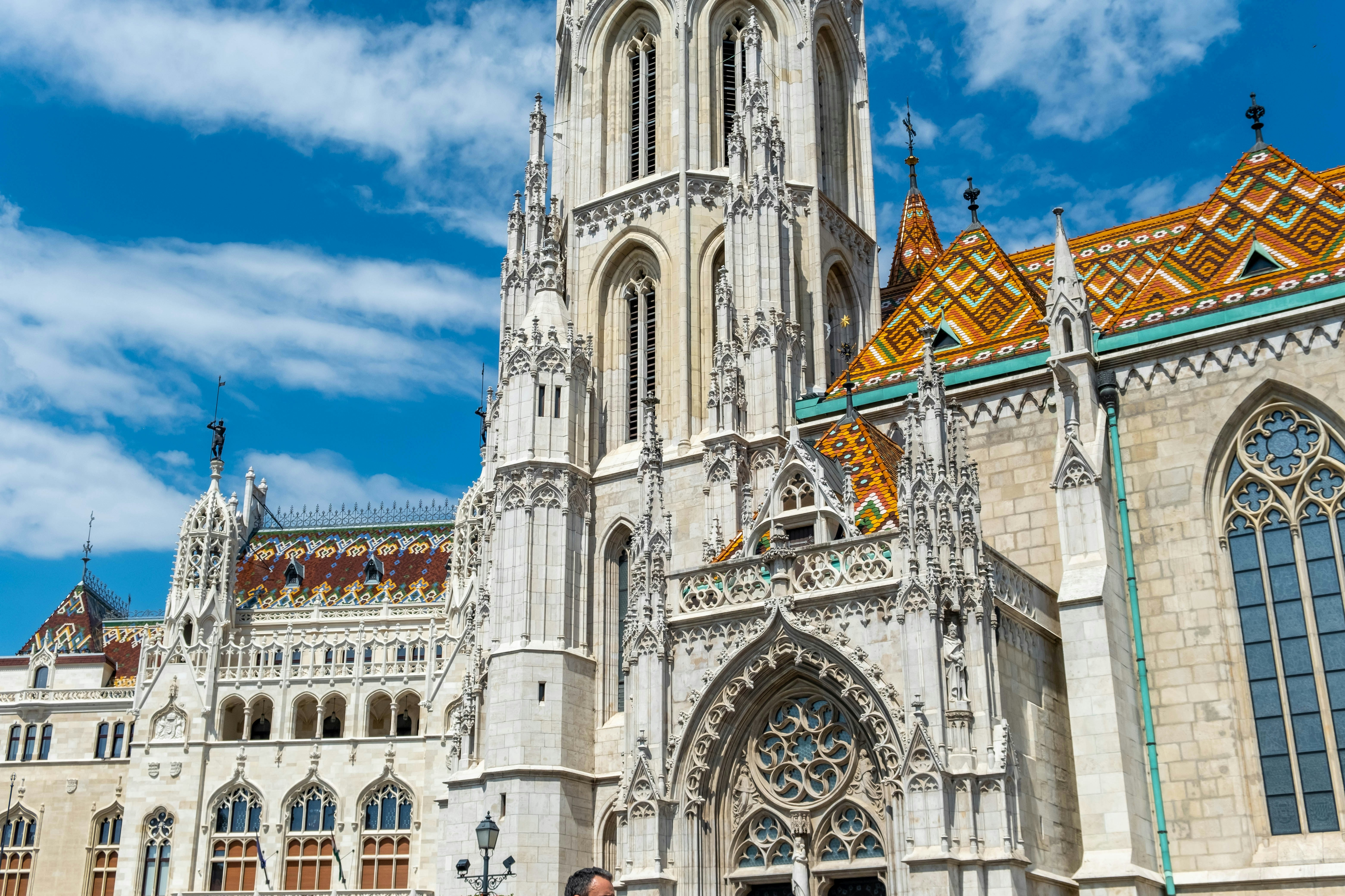 Gothic Grandeur: Facade Lines and Tile Roofs Against a Bright Sky