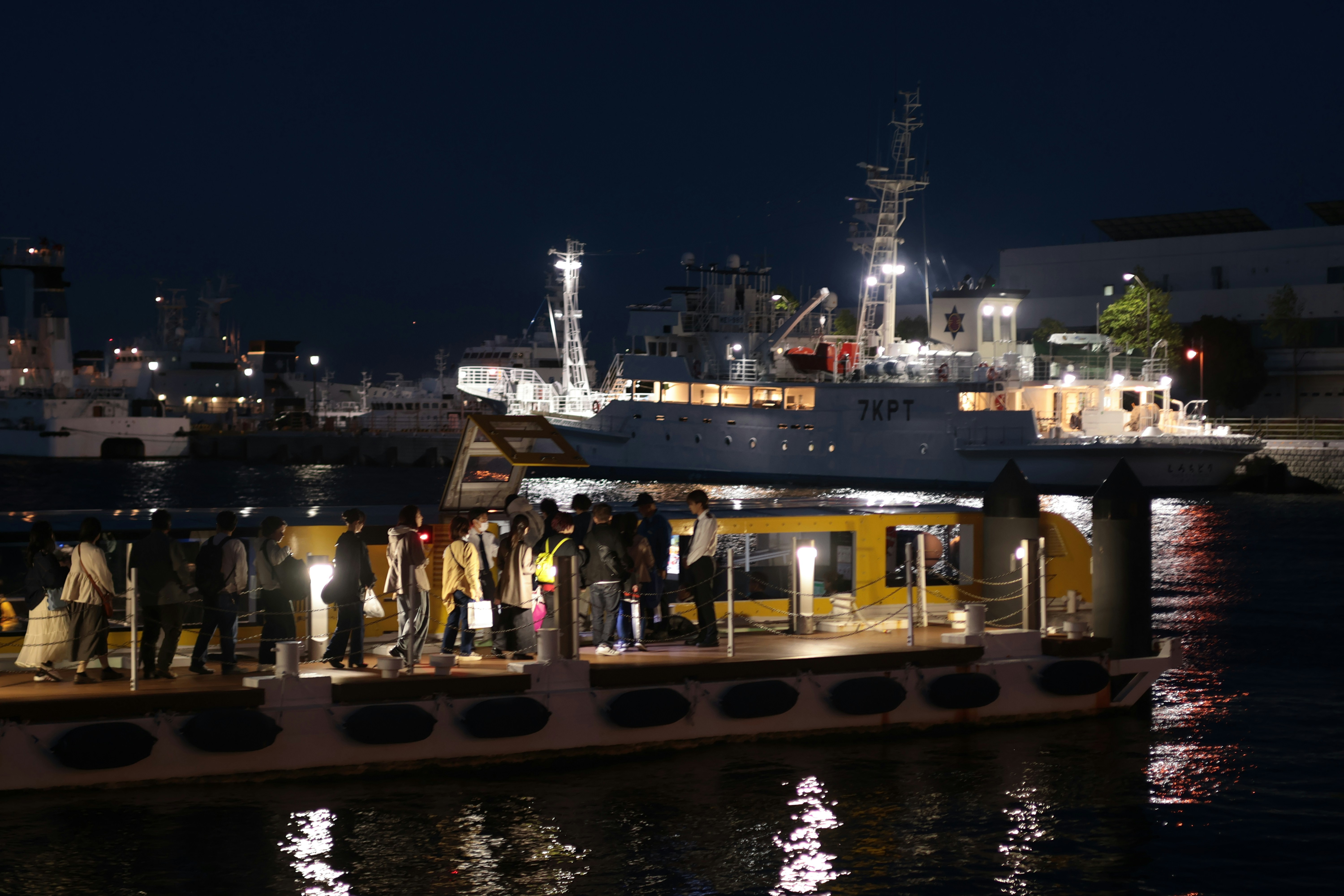Night Vessel Passengers on a Docked Boat Under Ambient Harbor Lights