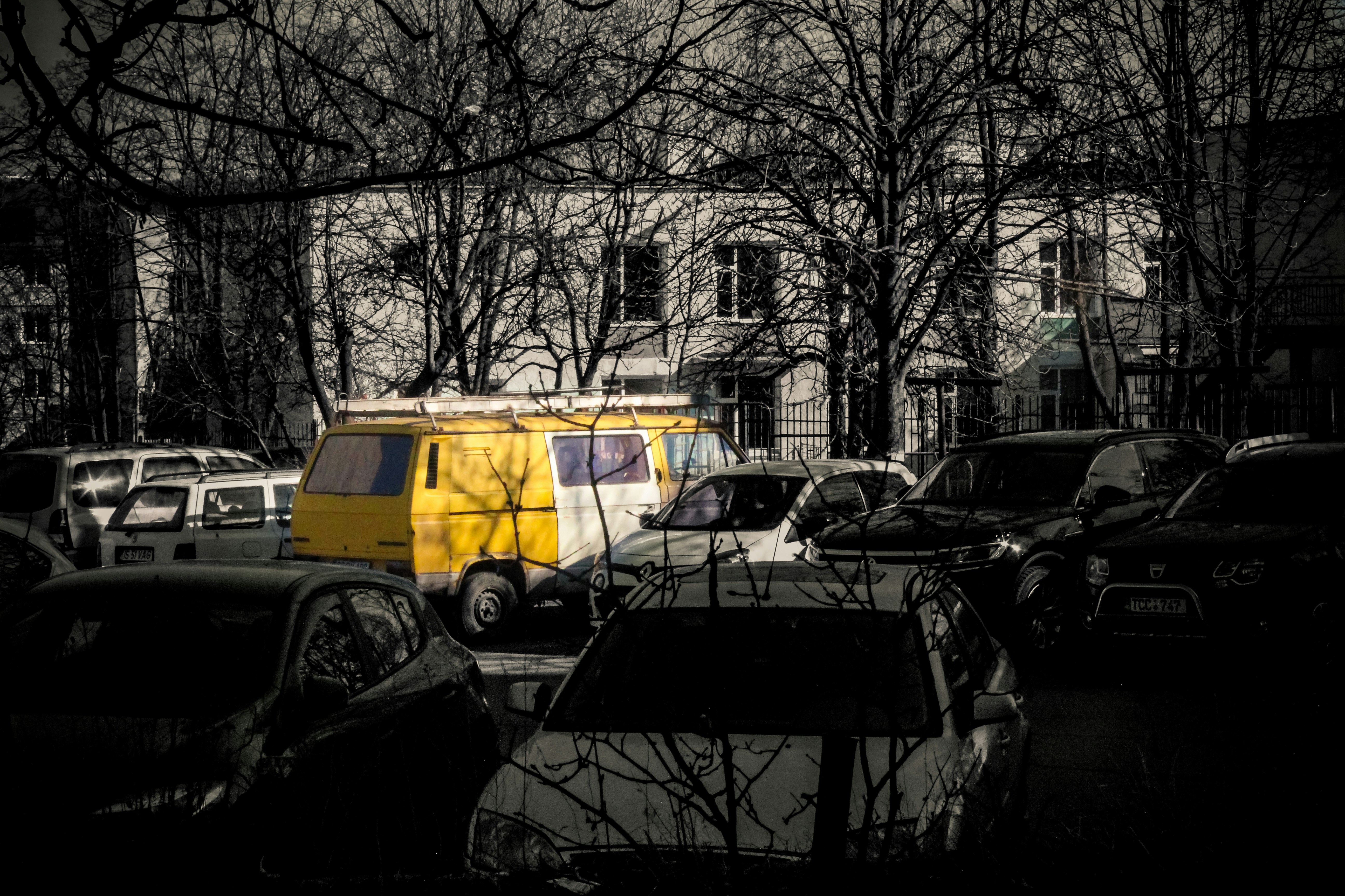 Muted City Ambulance: A Yellow Contrast Among Quiet Cars