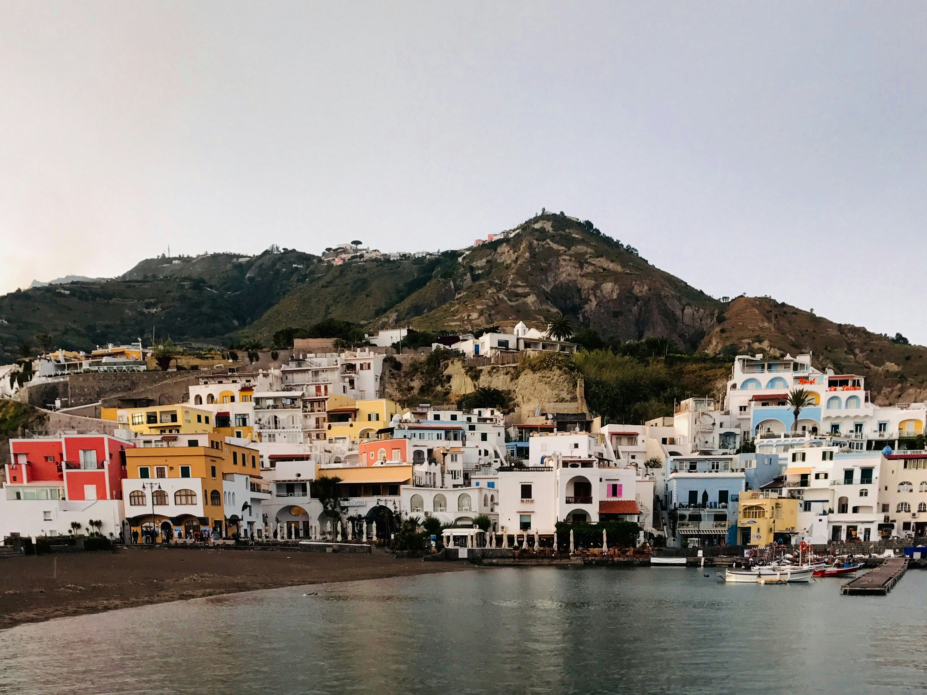 Colorful coastal village at the foot of a hill