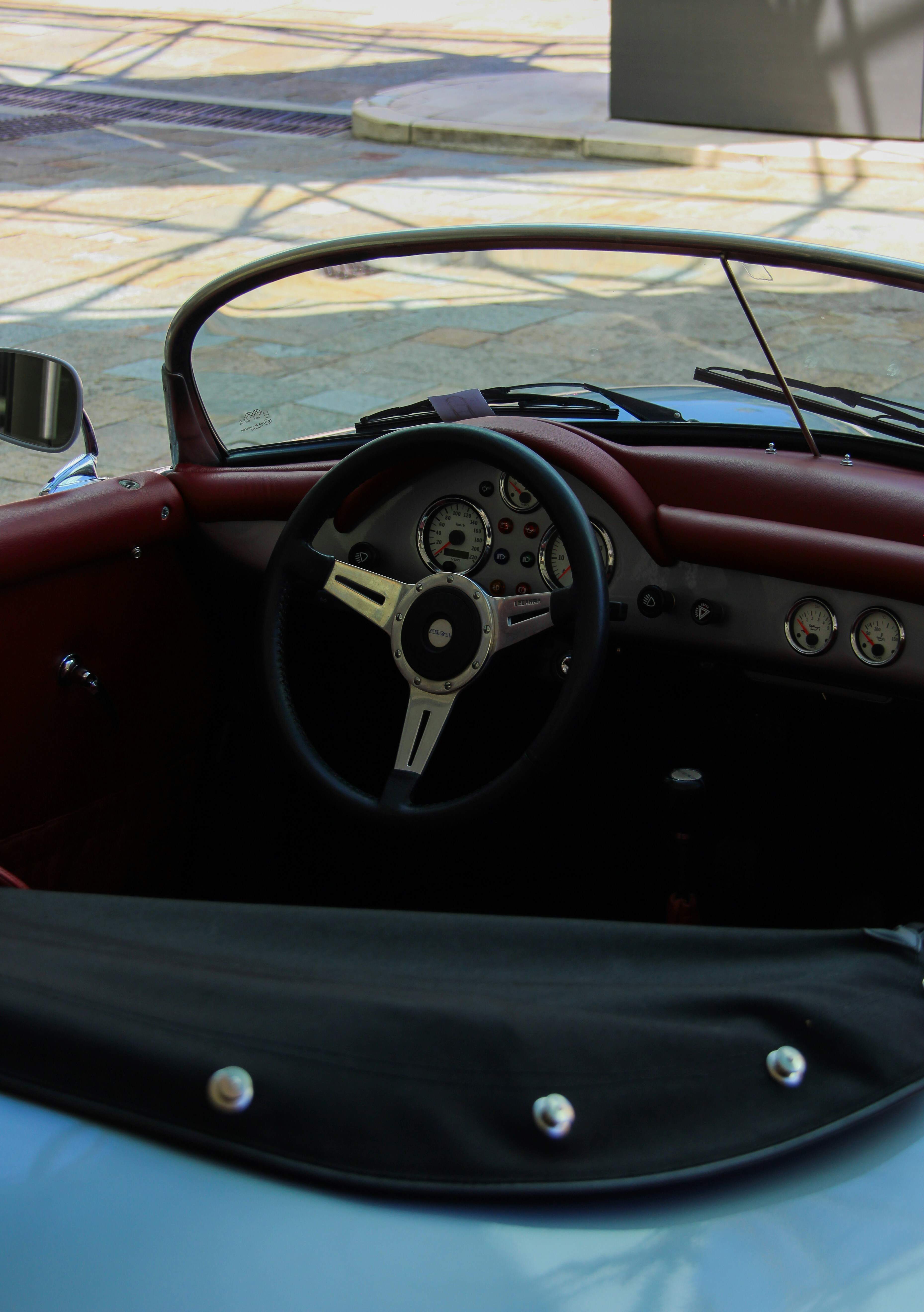 Red Roadster Cockpit: Vintage Gauge Echoes in Sunlit Open