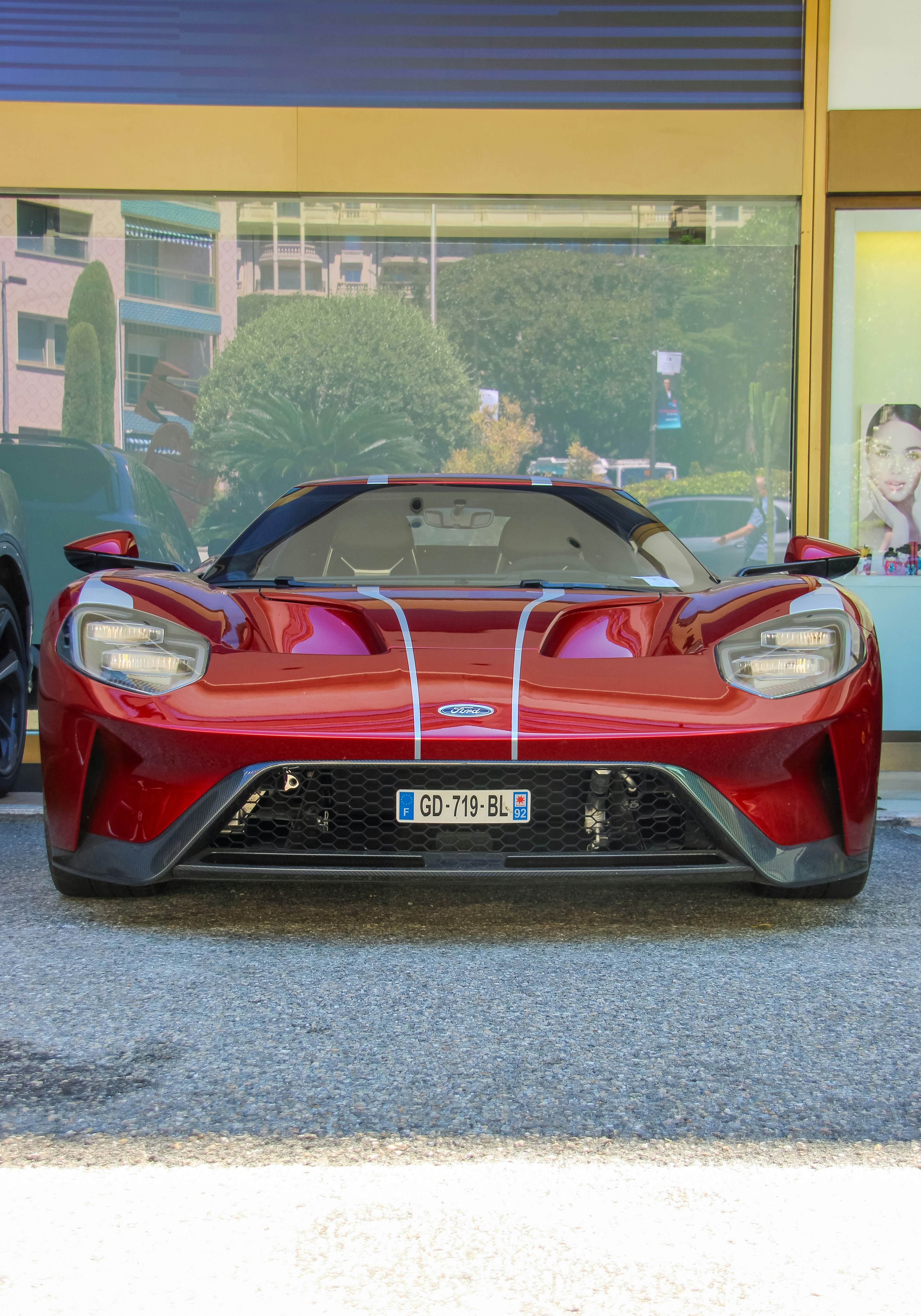 Red Ferrari-styled Escape: Front View of a Sleek Sports Car in Shopfront Light
