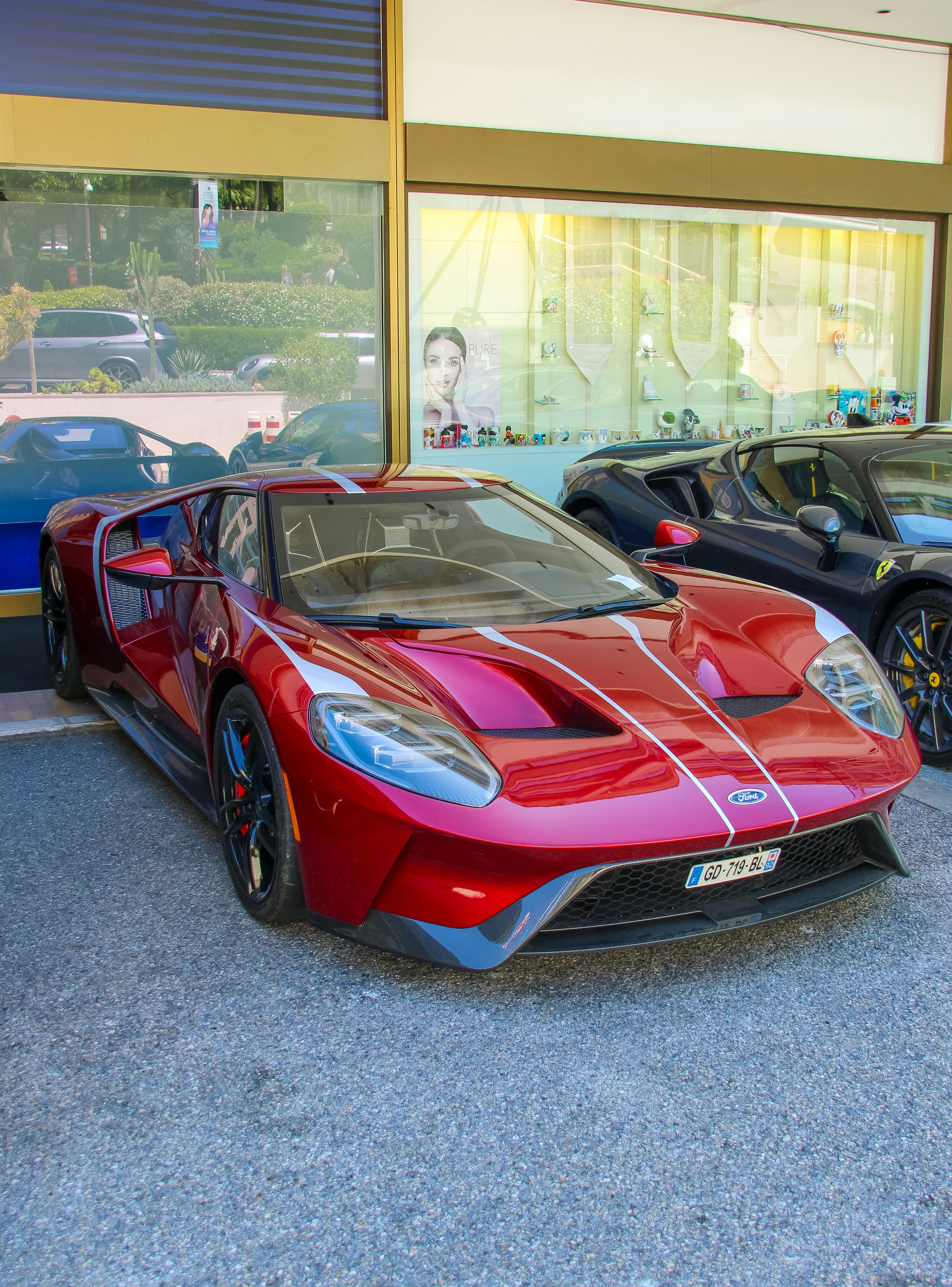 Red Hypercar in Front of Glass Shop Blends with Reflections