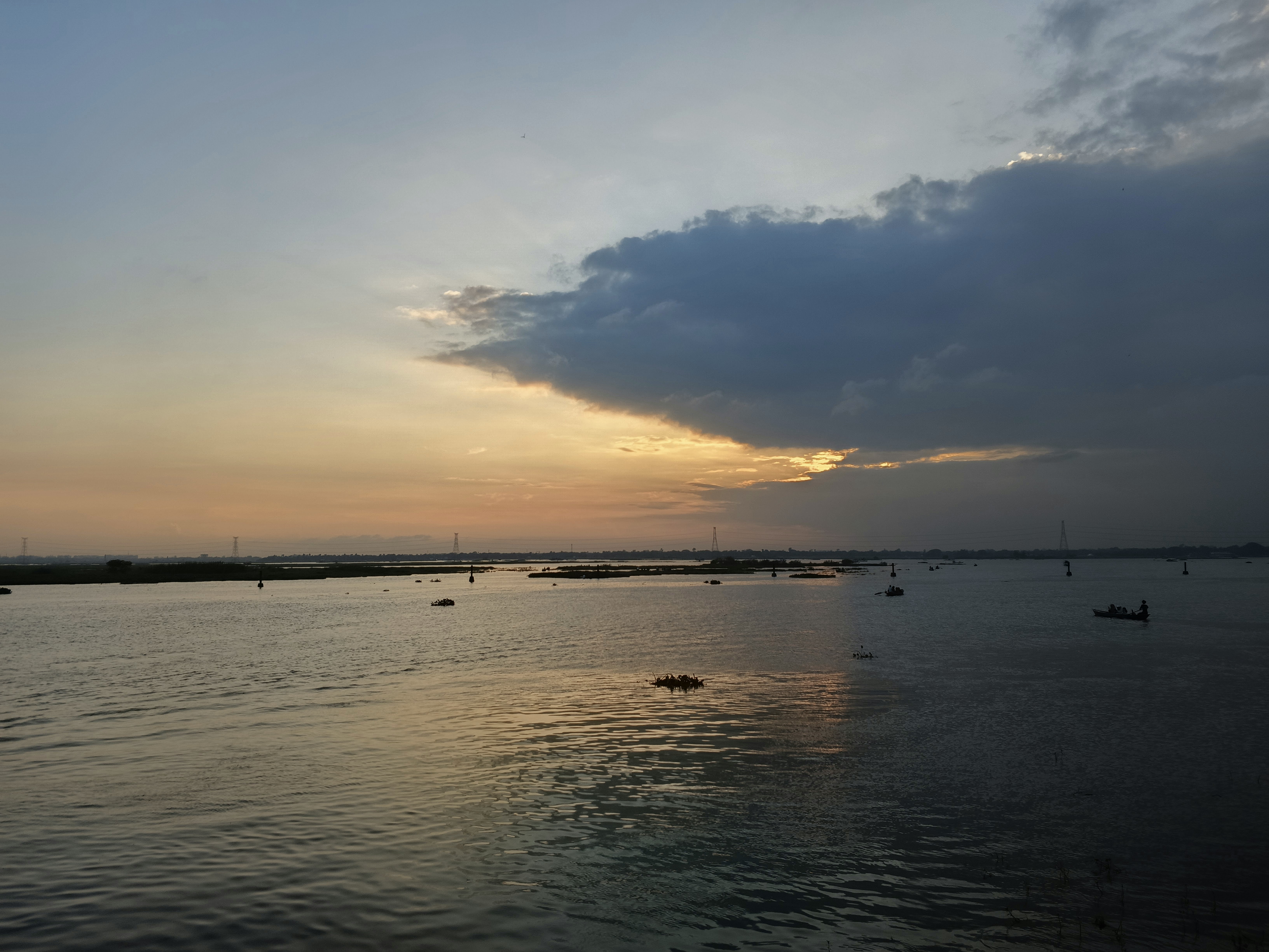 Dusk Over a Quiet Estuary: Boats and a Cloud-Edge Horizon