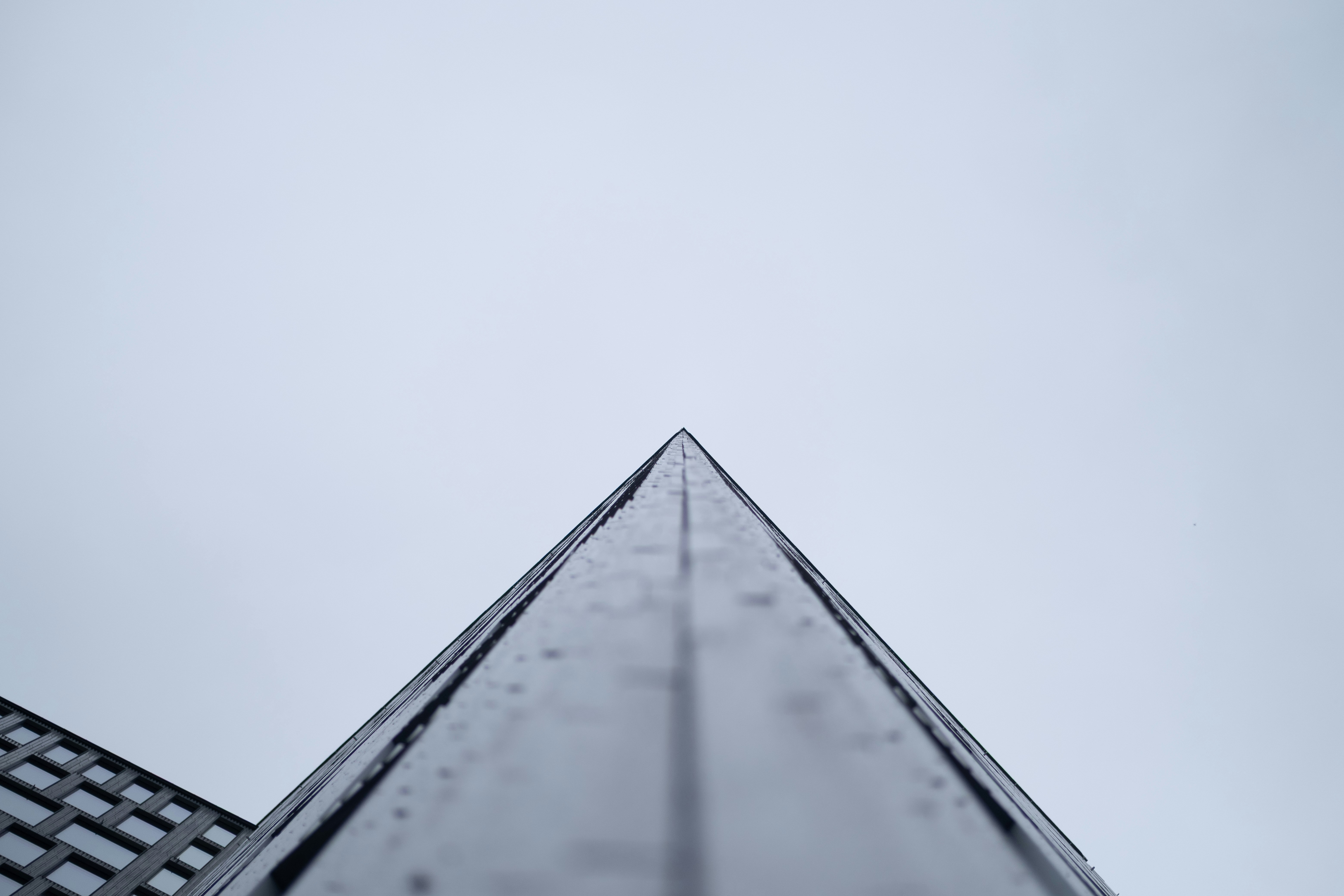 Rising Facade: A Monochromatic View Up from the Building Edge