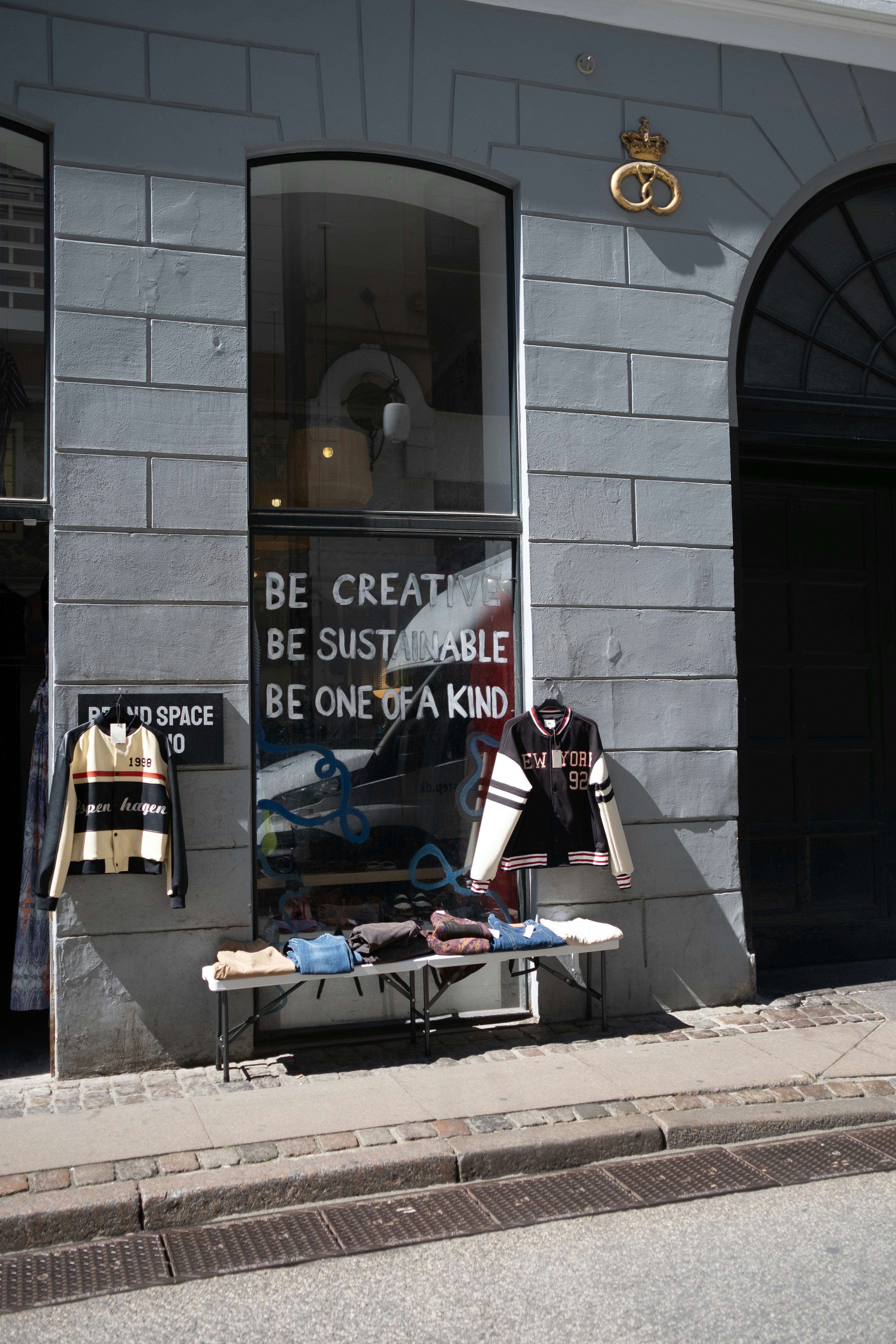 Streetfront Fashion Stand Under a Historic Archway