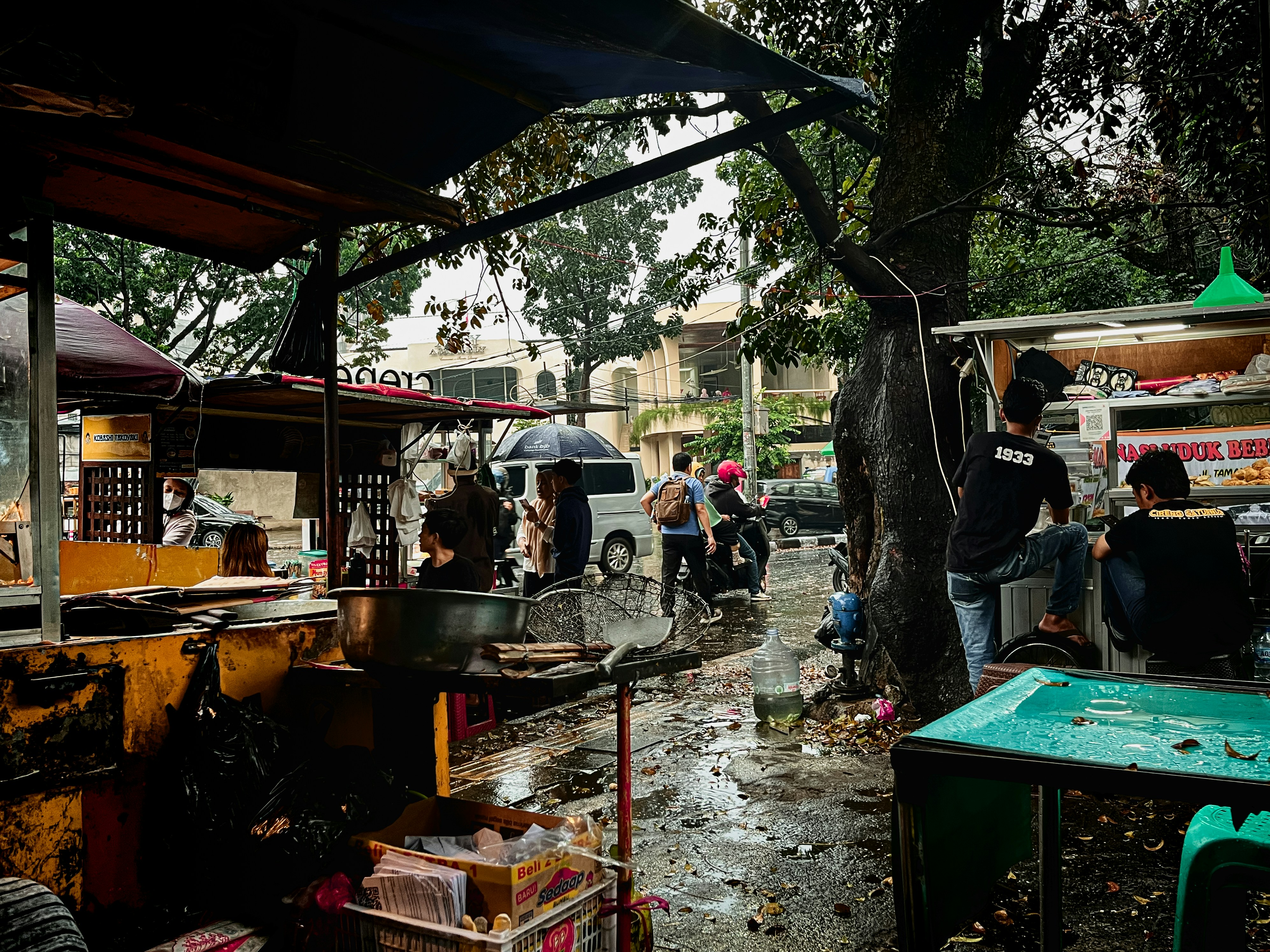 Rainy Street Food Huddle Under a Tree