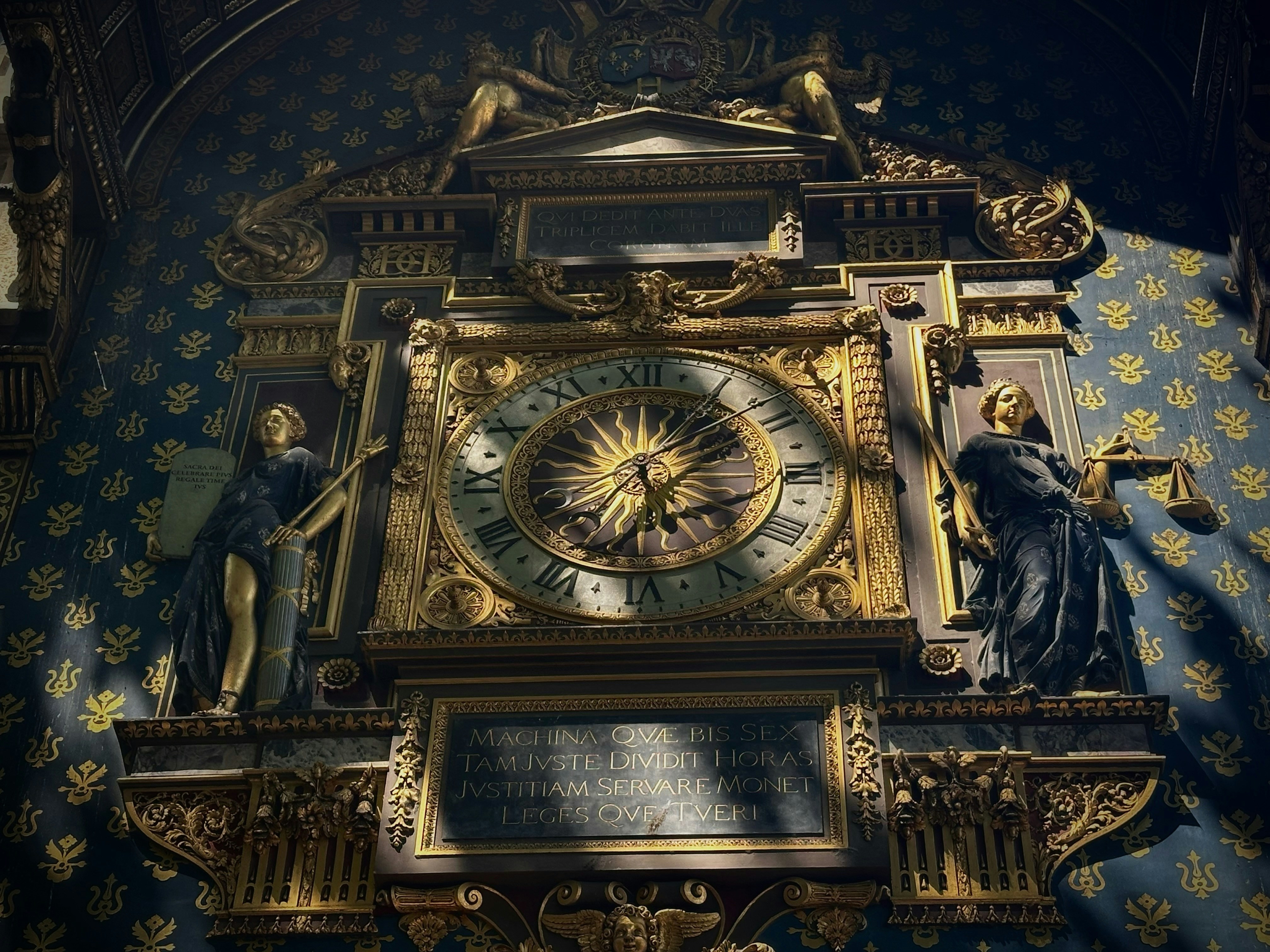 The gilded clockwork reliquary beneath guardian statues