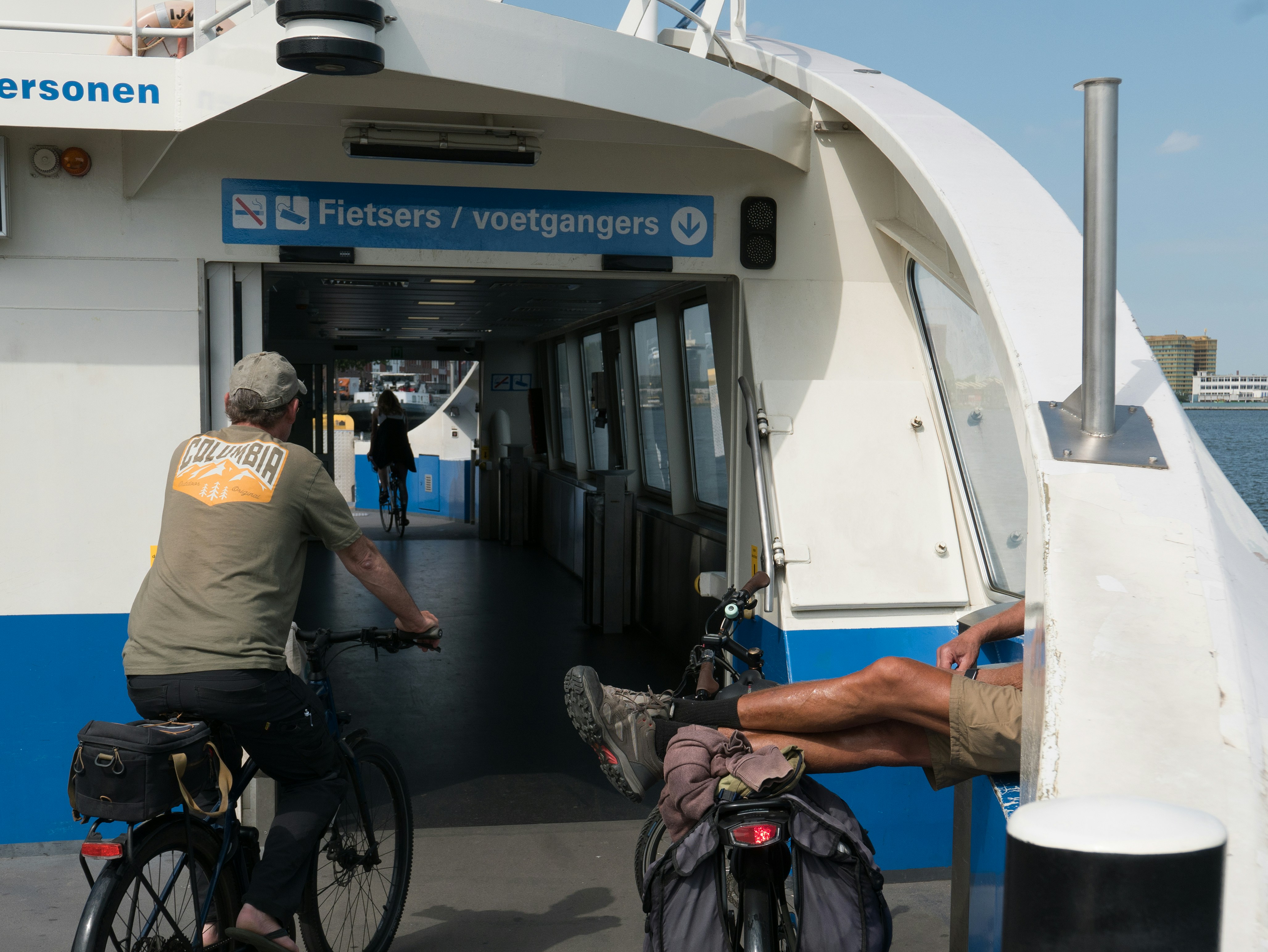 Riders Boarding a Ferry: A Shared Path Through the Passage