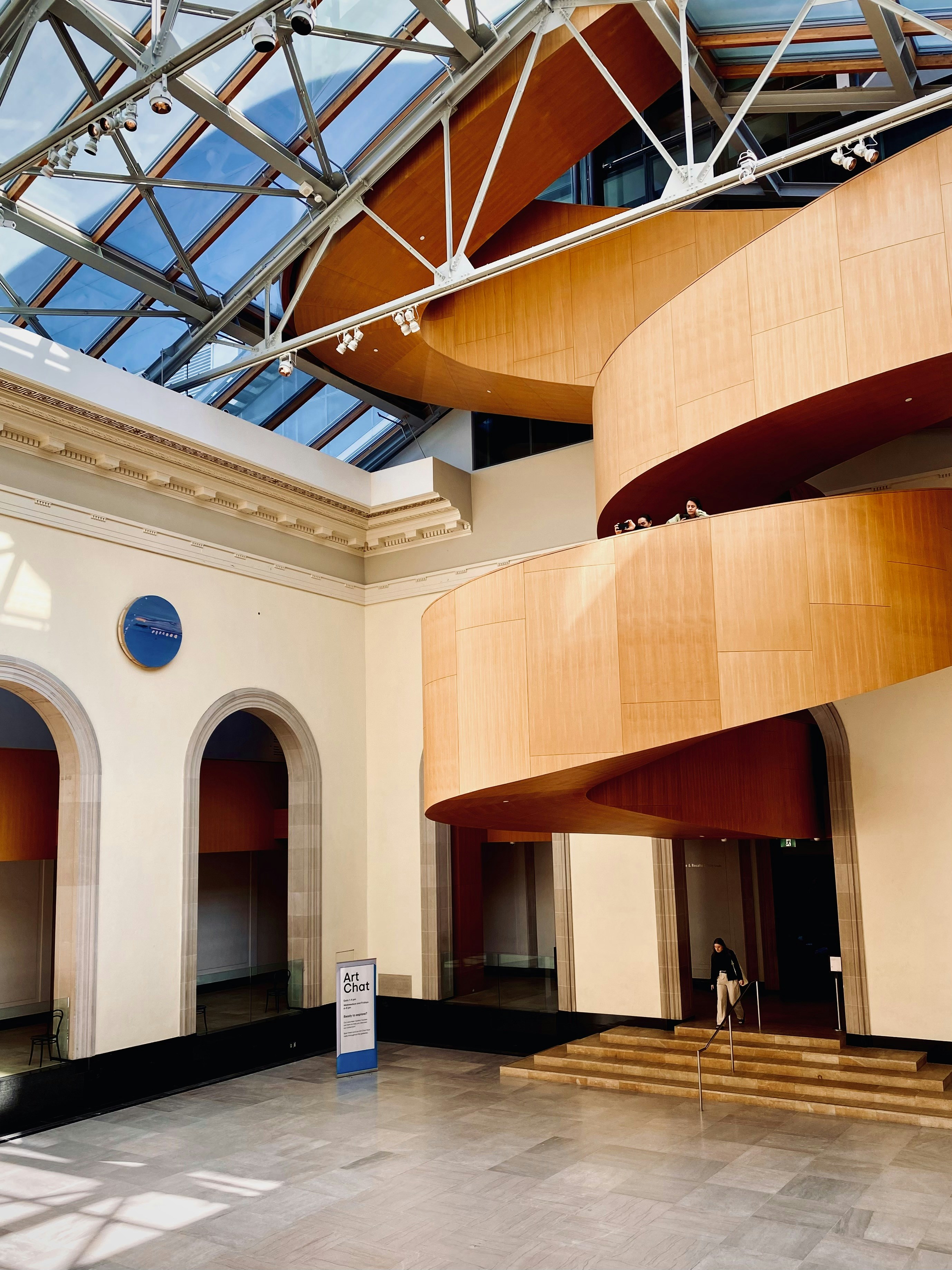 Spiral Timber Staircase in Sunlit Museum Atrium