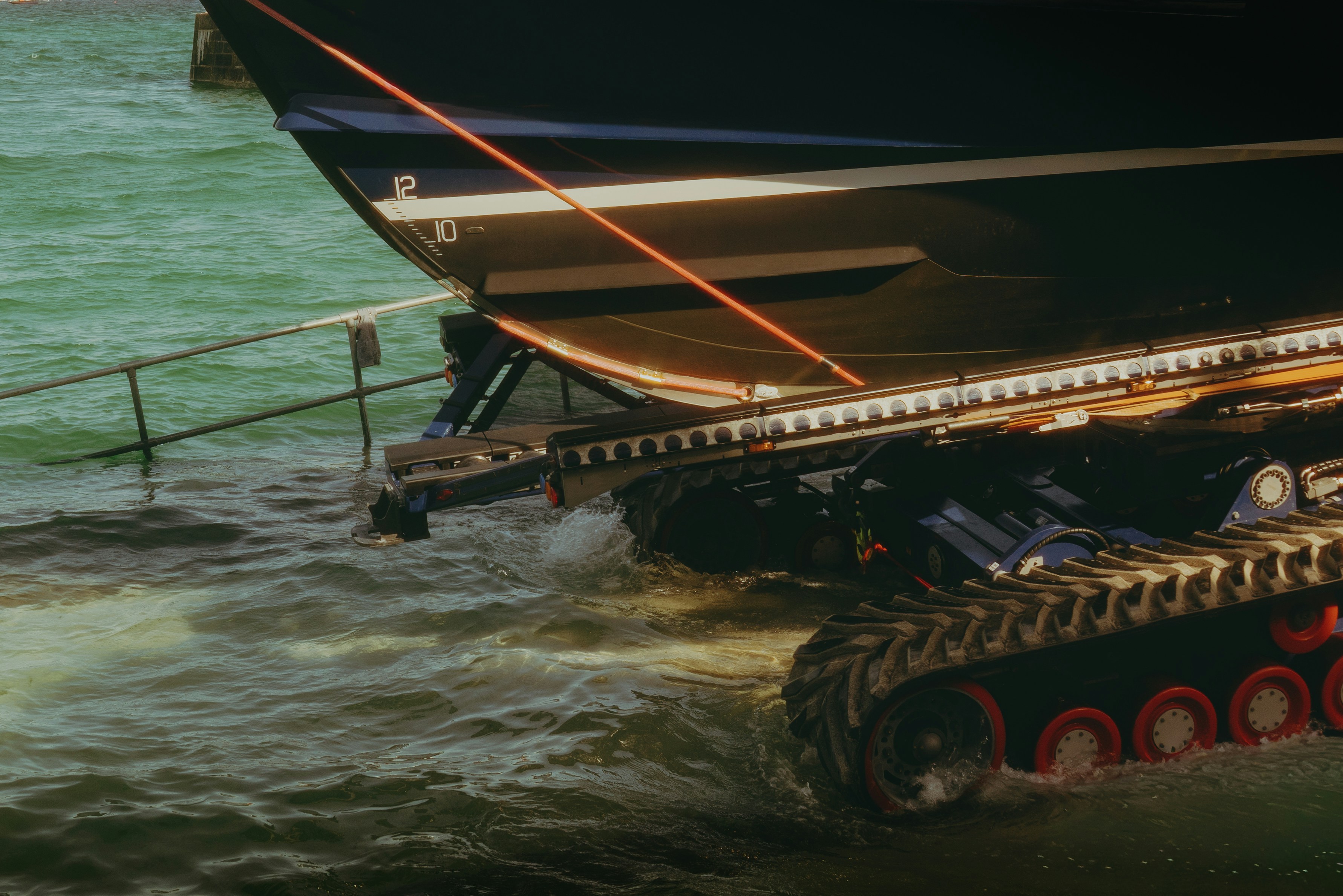 Dockside Descent: A Boat Resting on Treads near Turquoise Water
