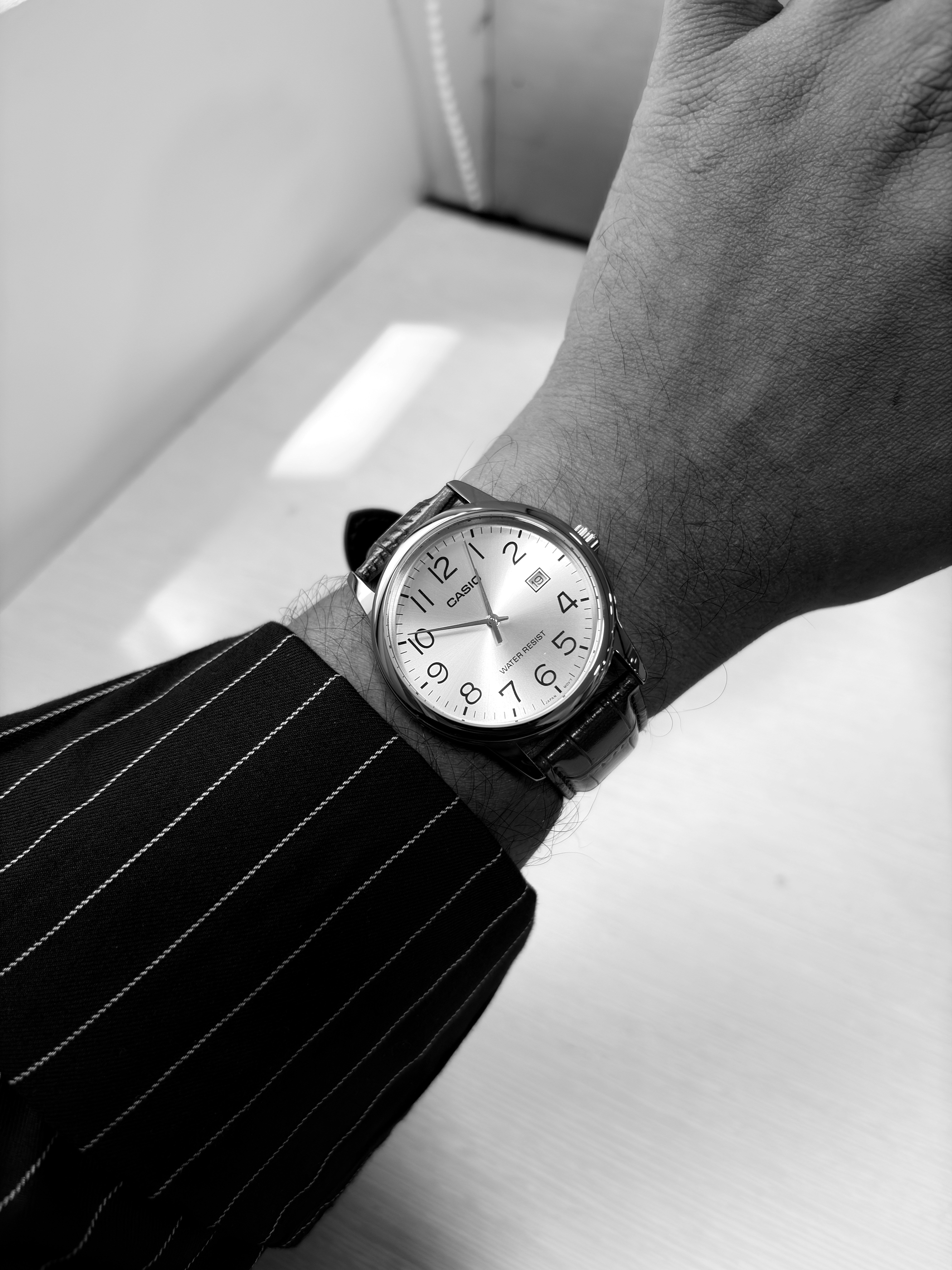 Wristwatch in a striped sleeve: a monochrome study of time